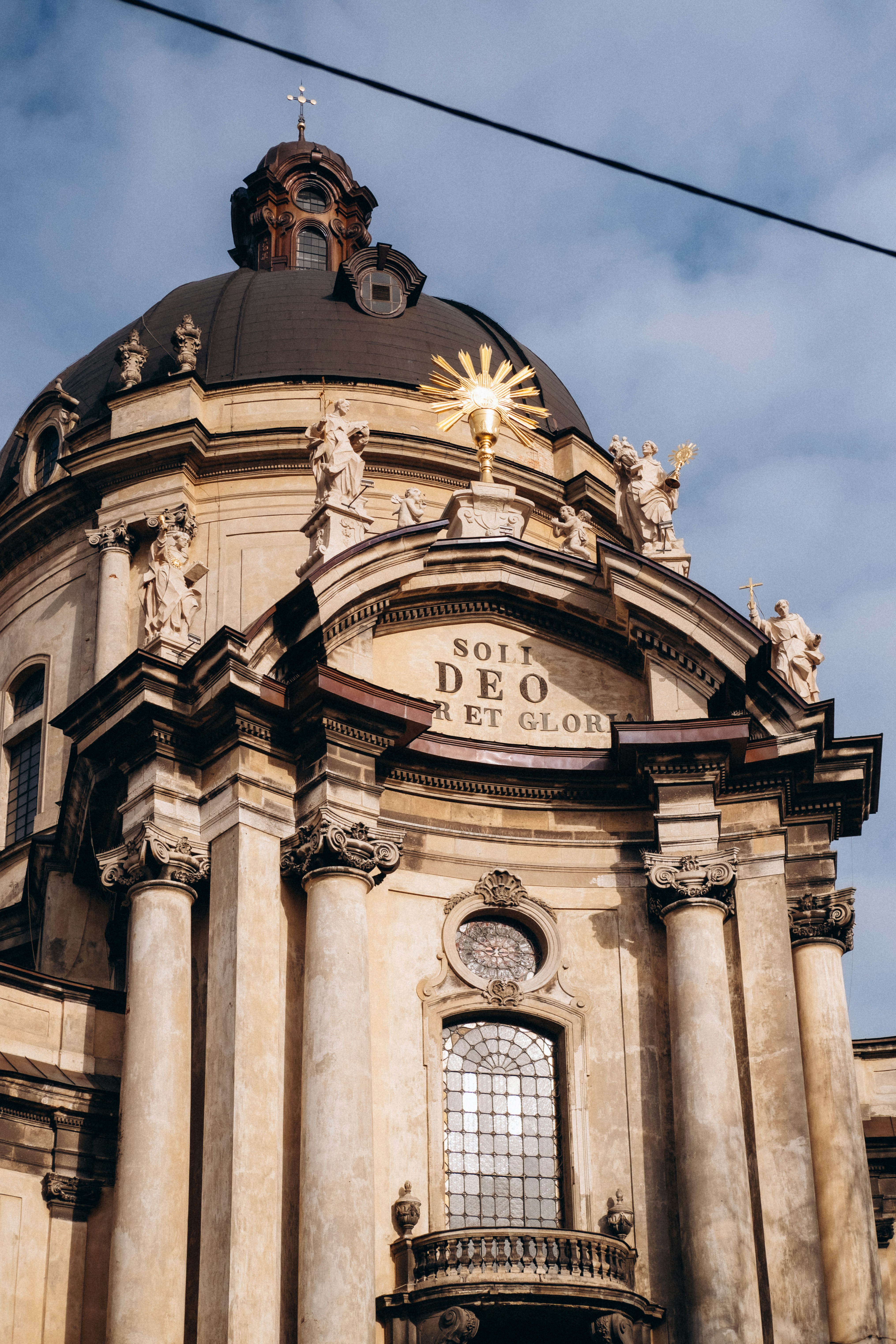 Soli Deo Gloria: Sculpted Crown Over a Baroque Cathedral