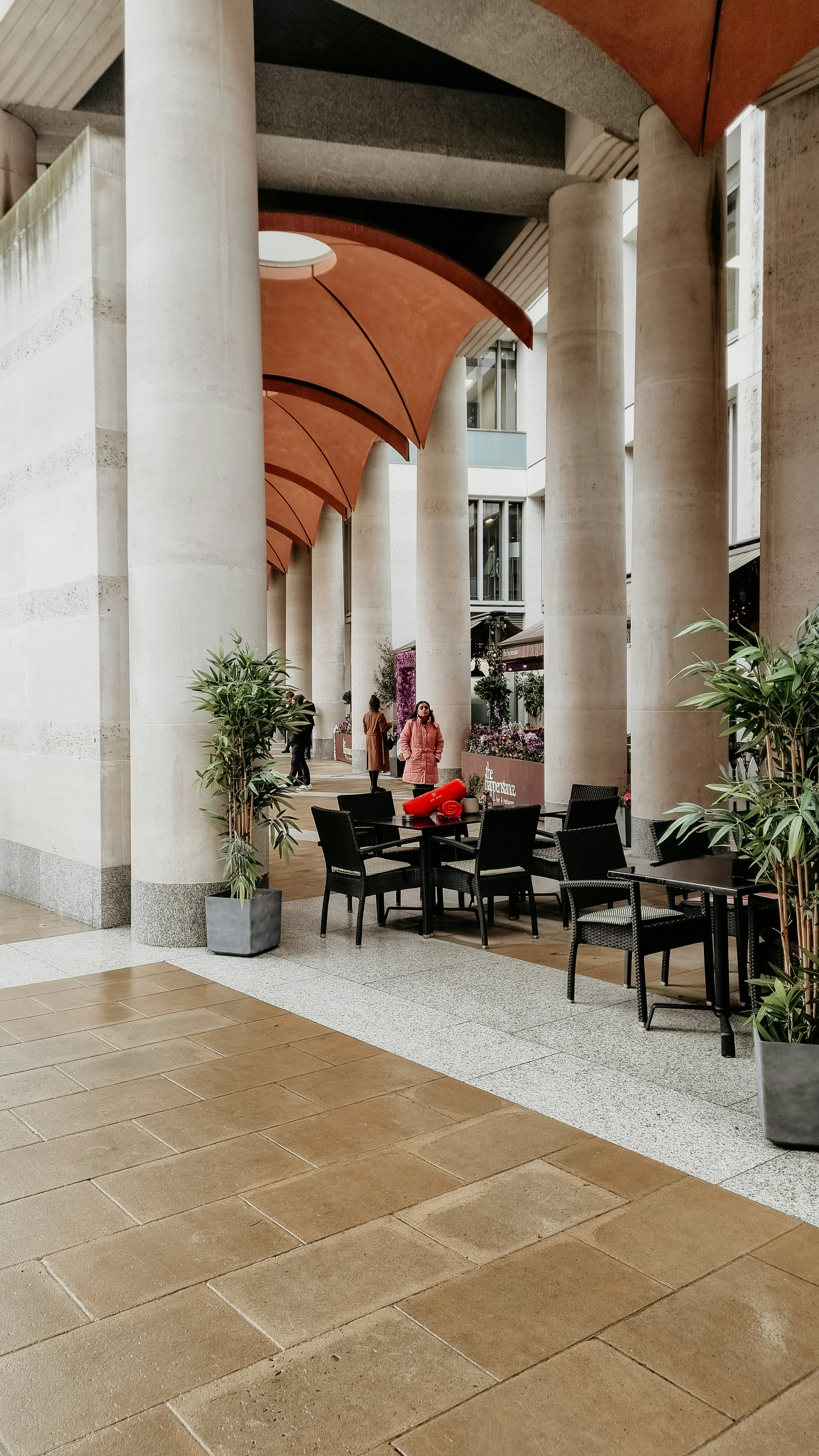 Under the orange arches: a courtyard cafe between towering columns