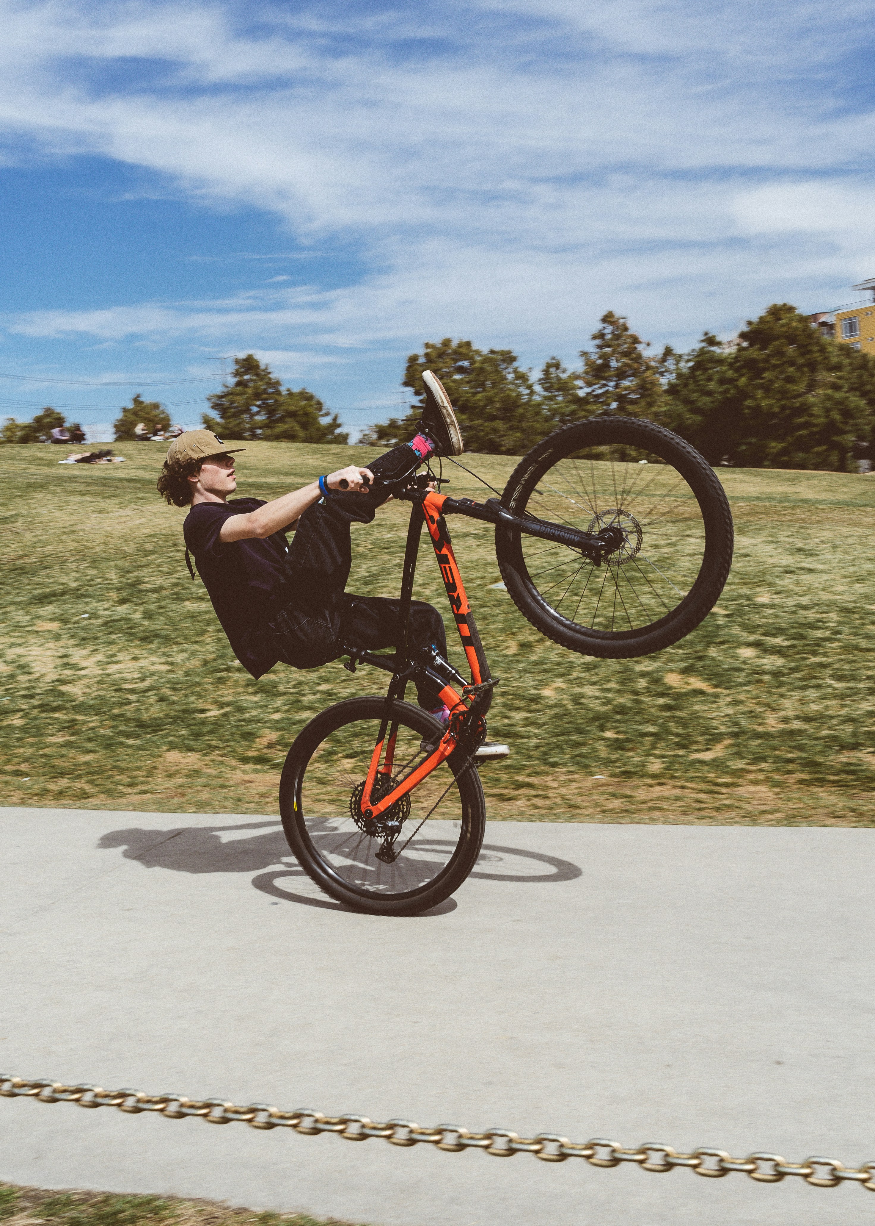 a man doing a trick on a bike on a sidewalk
