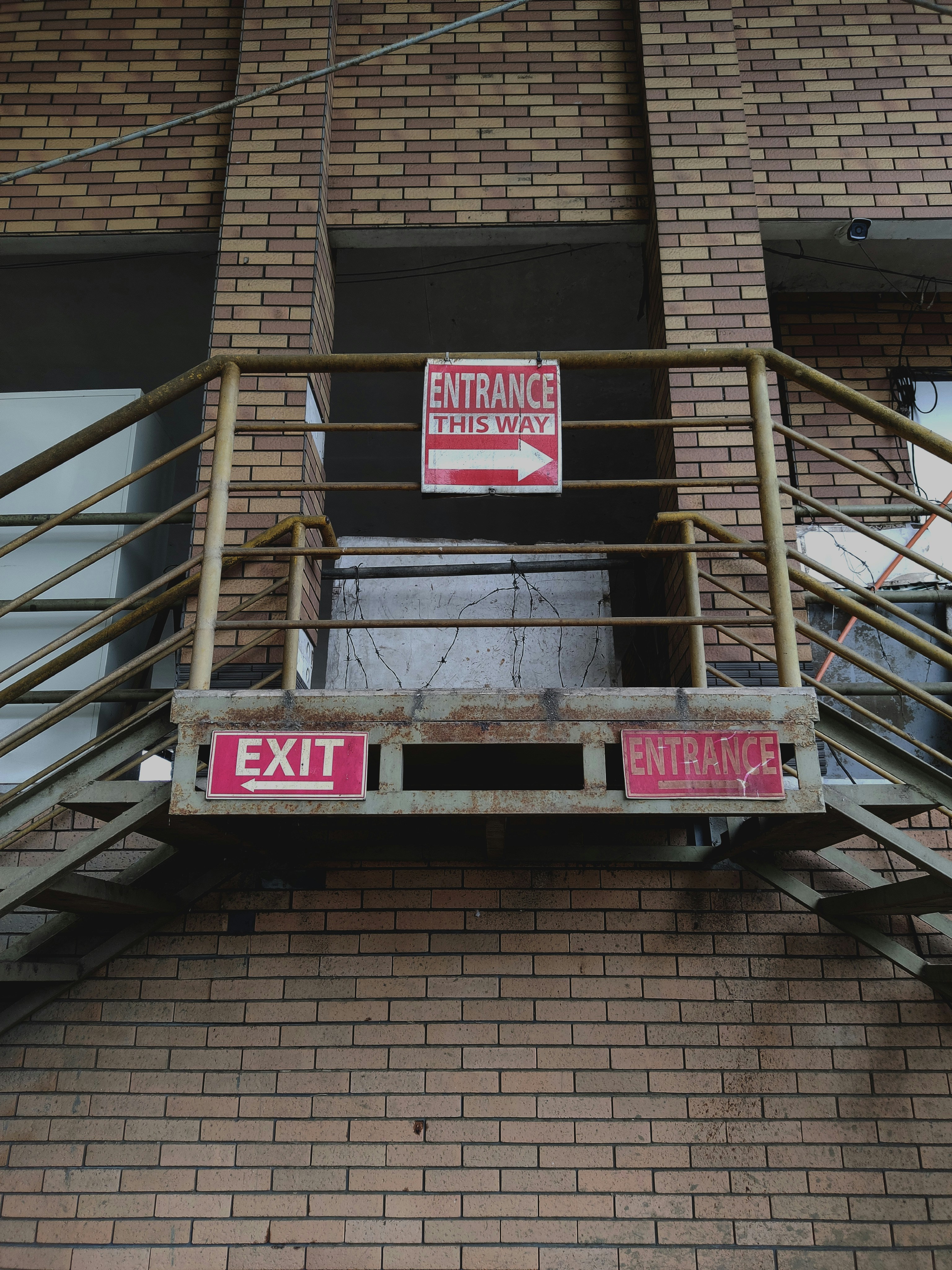 Two red and white signs on a brick building photo – Free Entrance Image ...