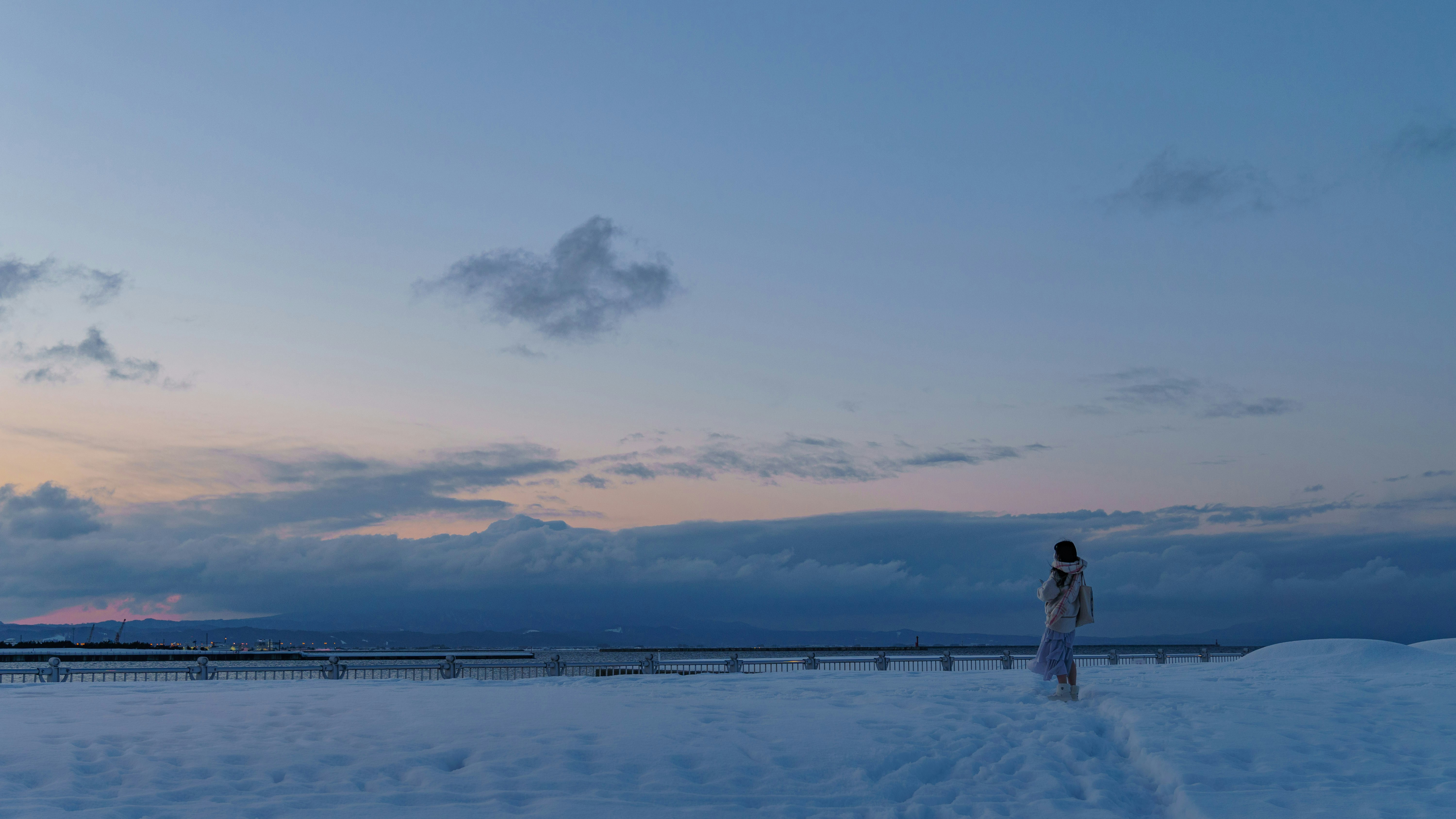 a person standing next to a body of water