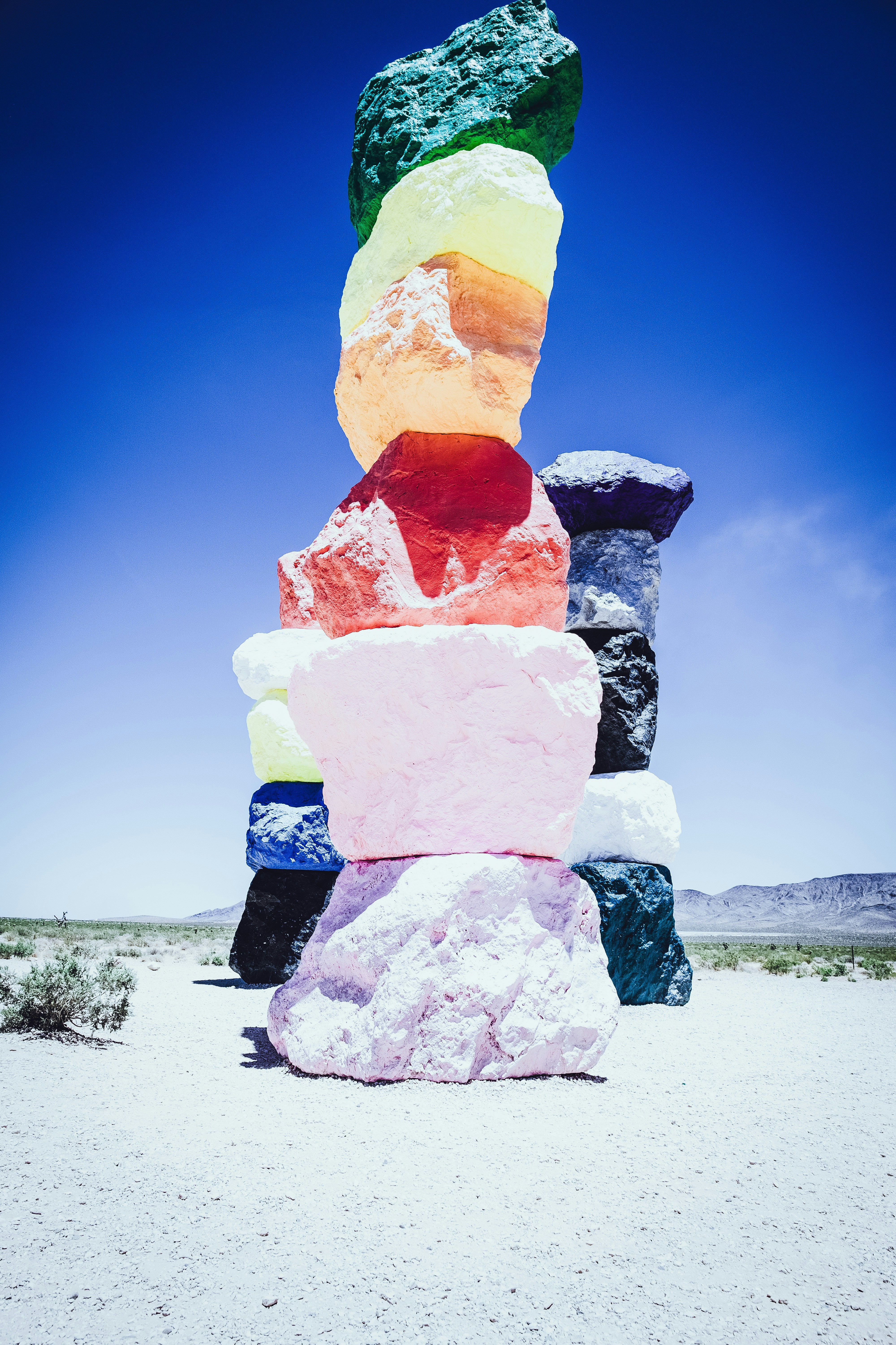 a large stack of rocks sitting on top of a sandy beach