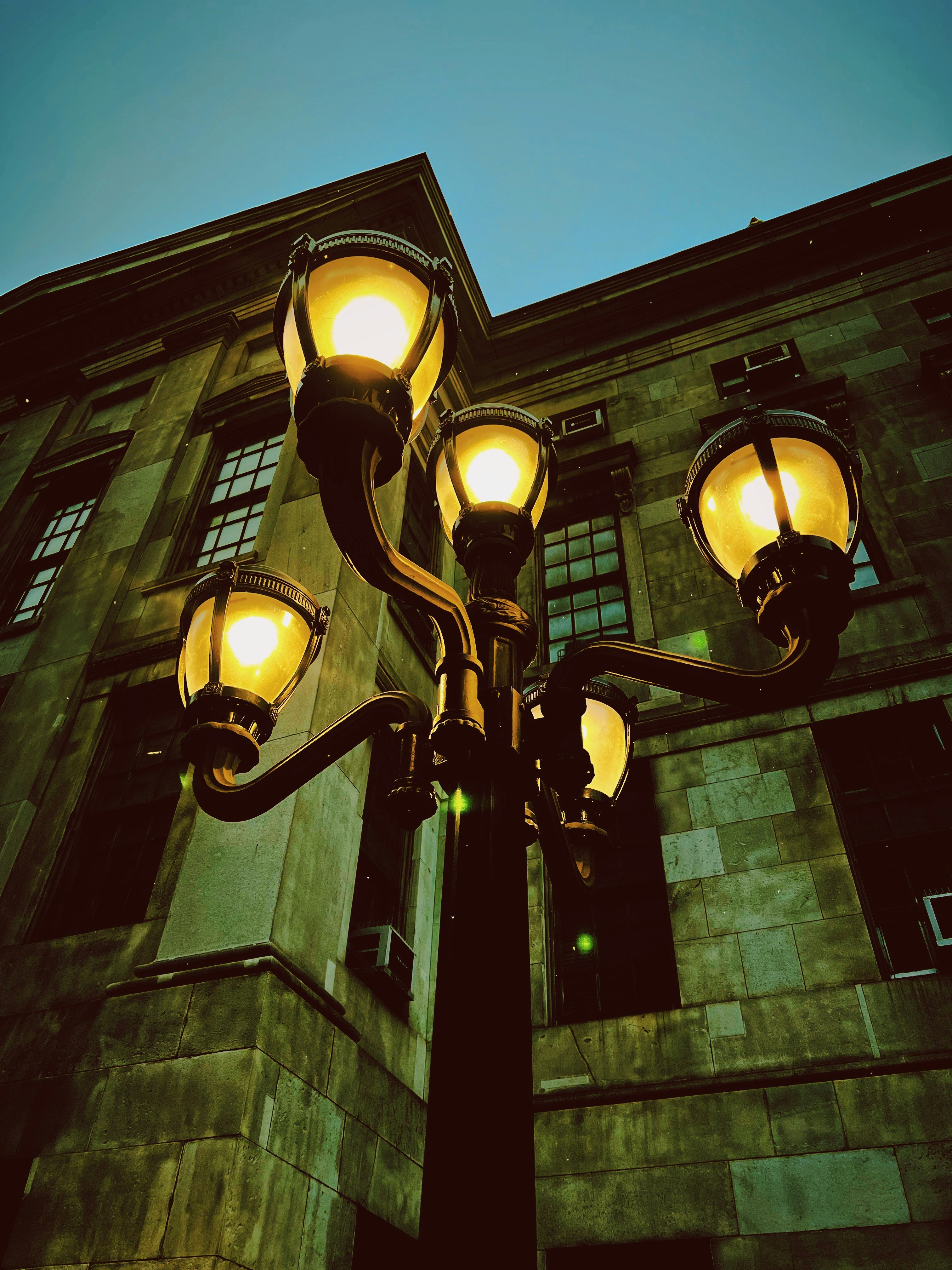 A street light in front of a tall building photo – Free Lamp post Image ...