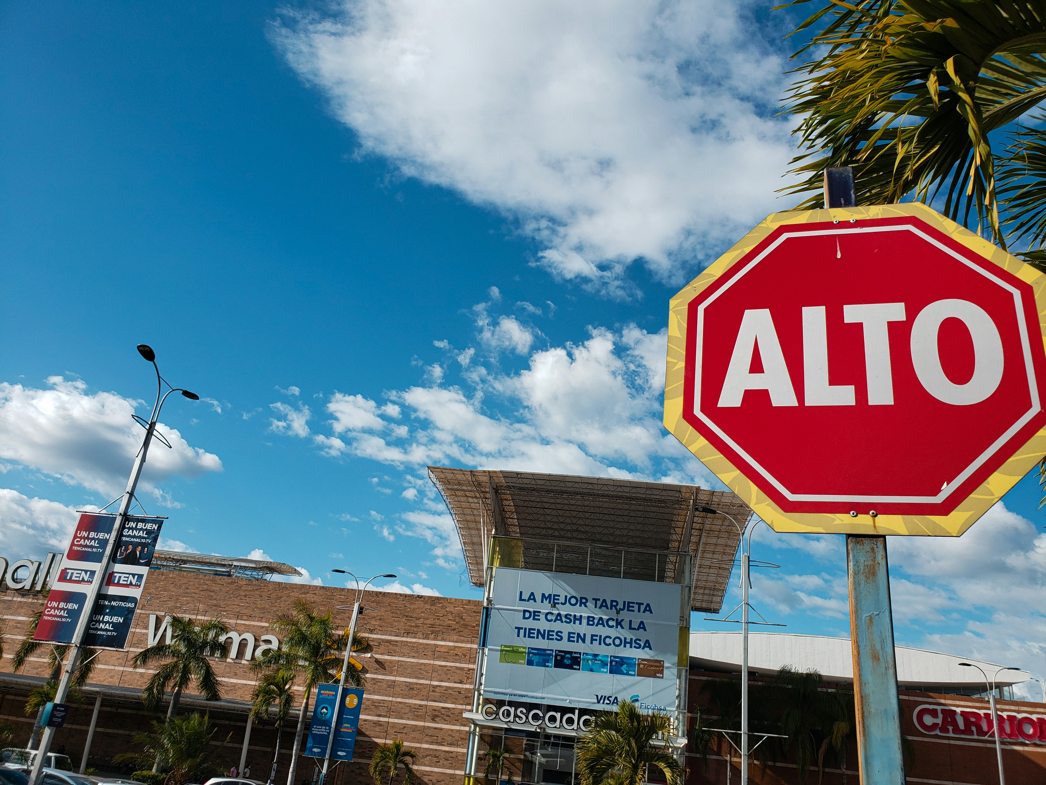 Alto at Full Sun: A Bold Stop Sign Framed by a Sunny Mall Exterior