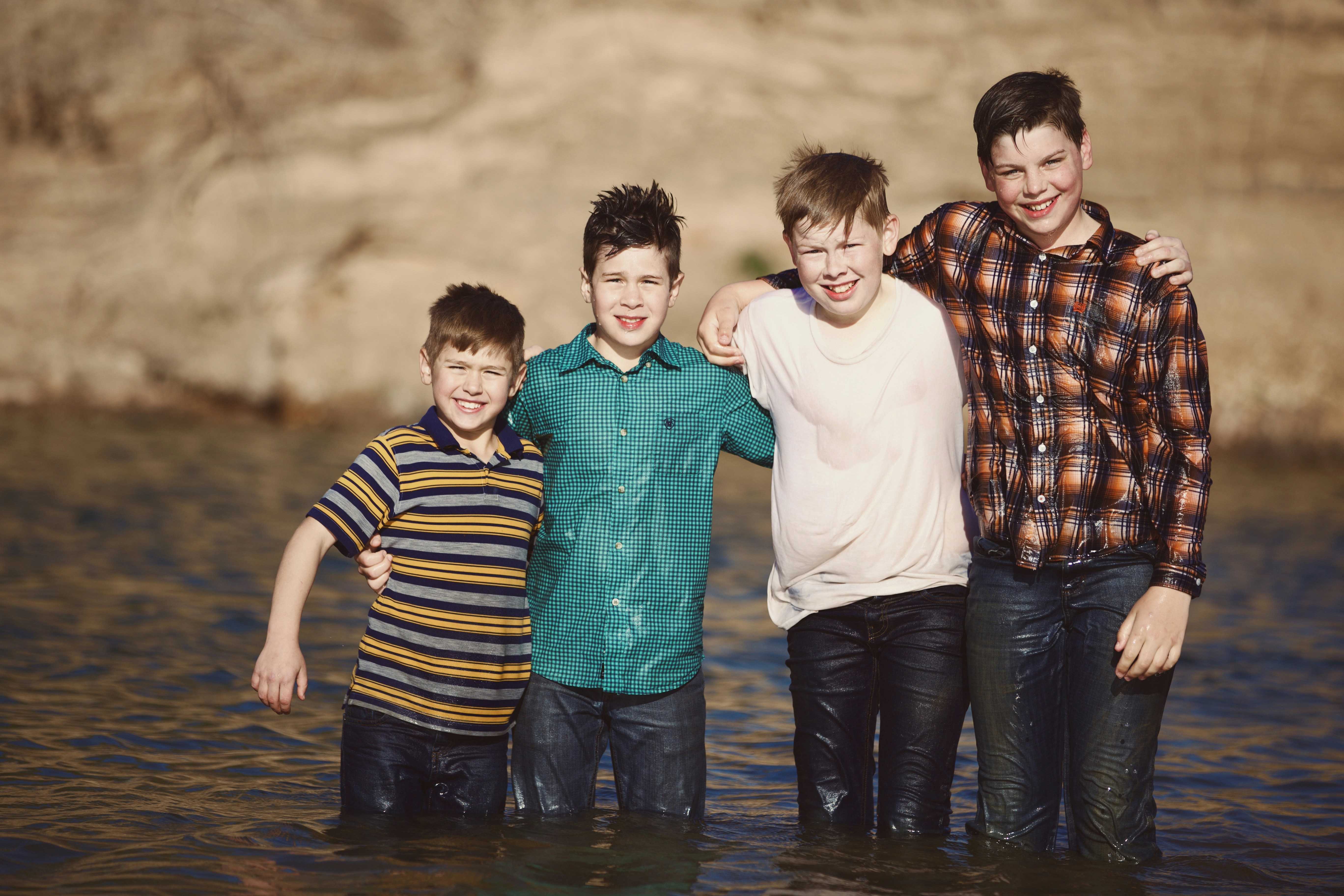 Sunlit Shoreline Portrait: Four Friends in Warm Coastal Light