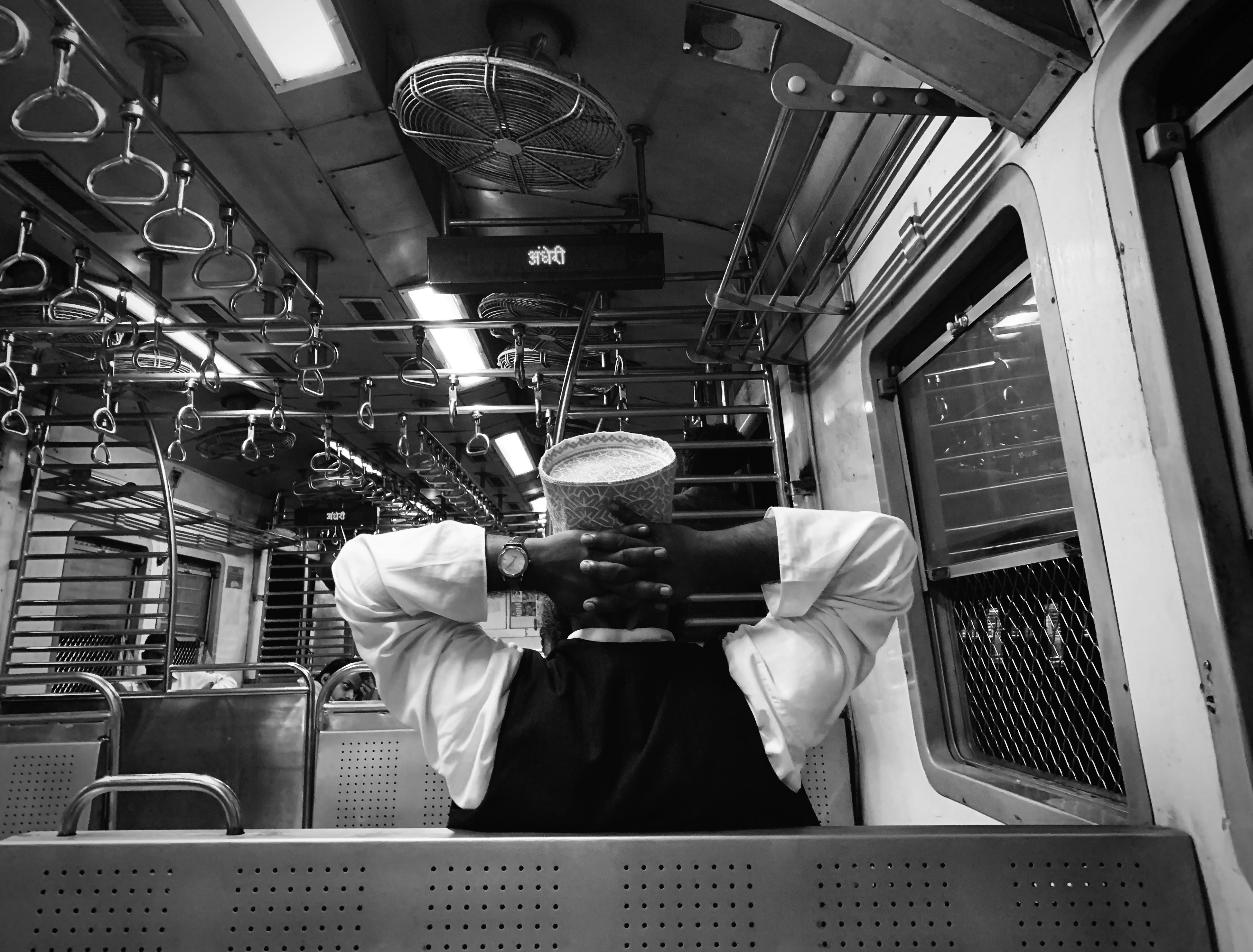 Backlit in the Aisle: A Quiet Moment of Pause on Board