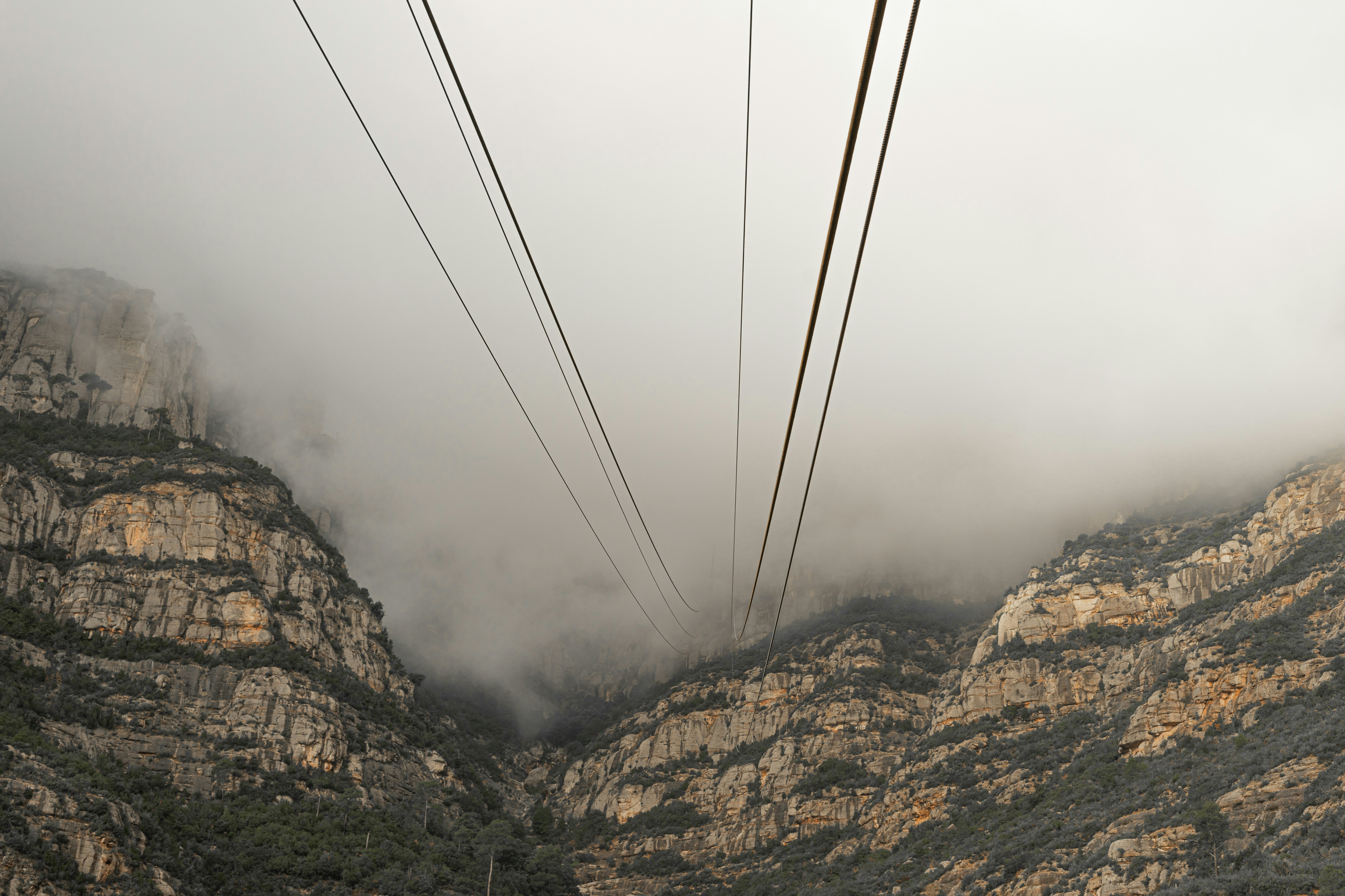 a view of a mountain with a cable car going up it