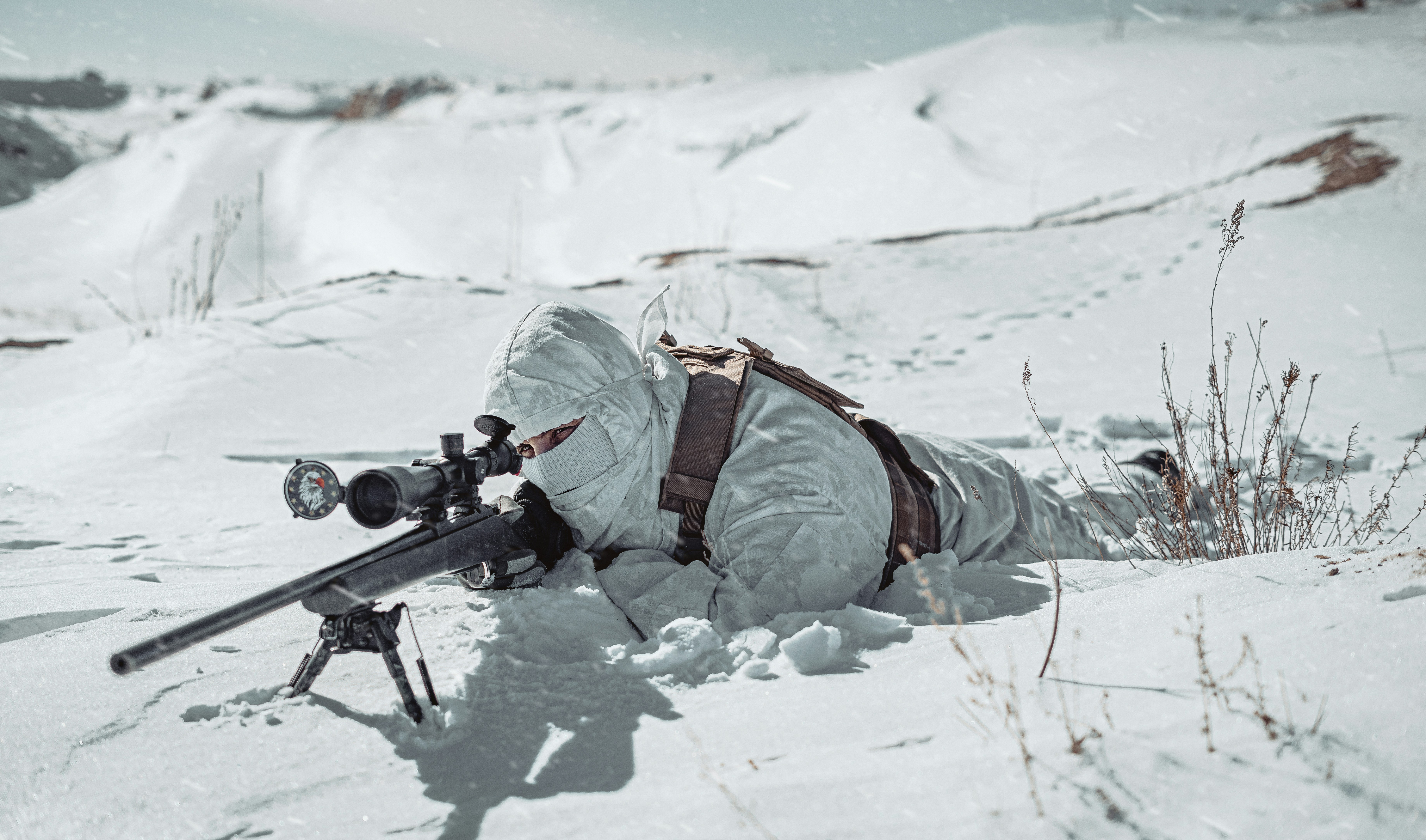 A man laying in the snow with a rifle photo – Free Astana Image on Unsplash