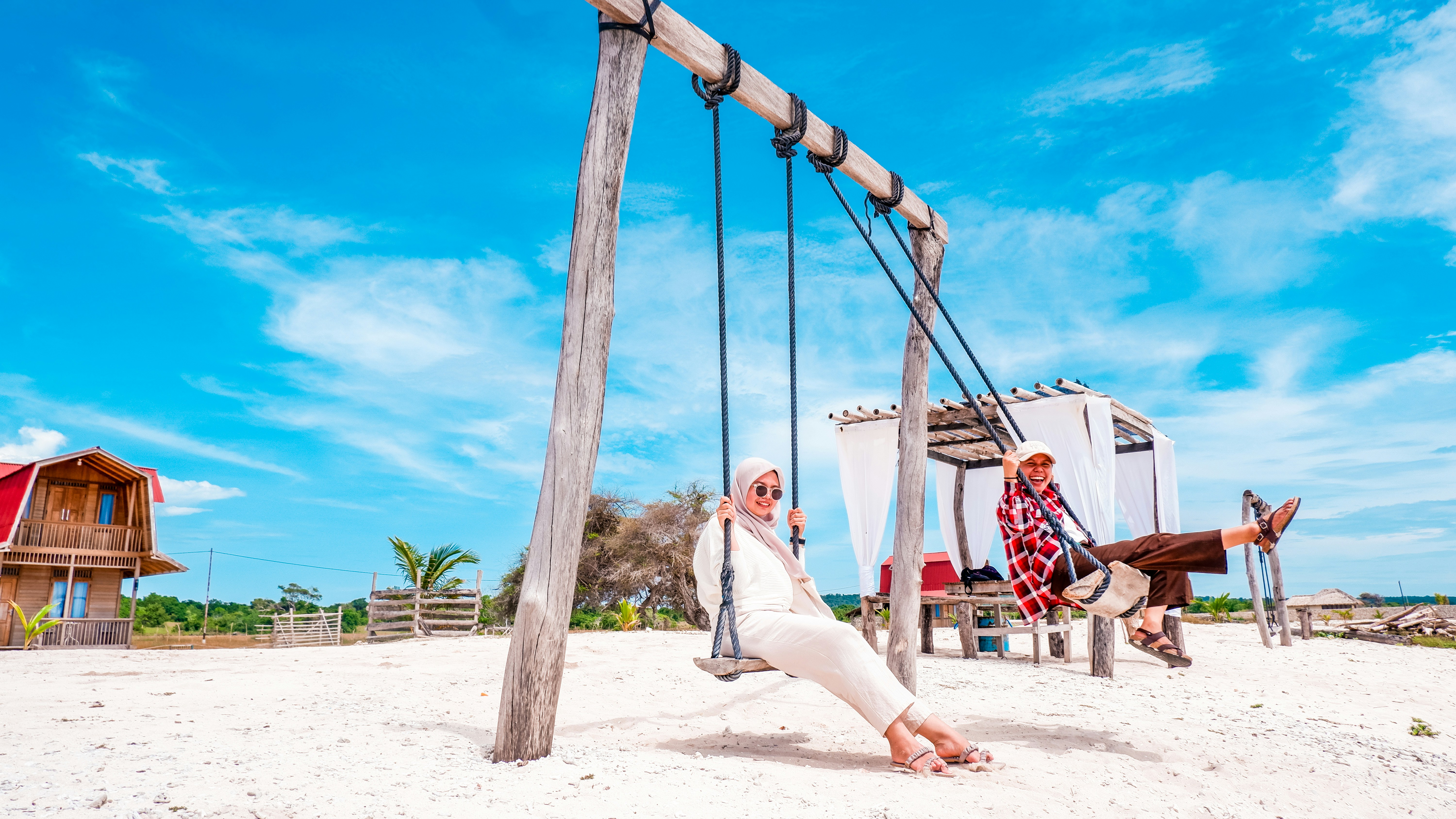 A couple of people that are on a swing photo – Free Person Image on ...