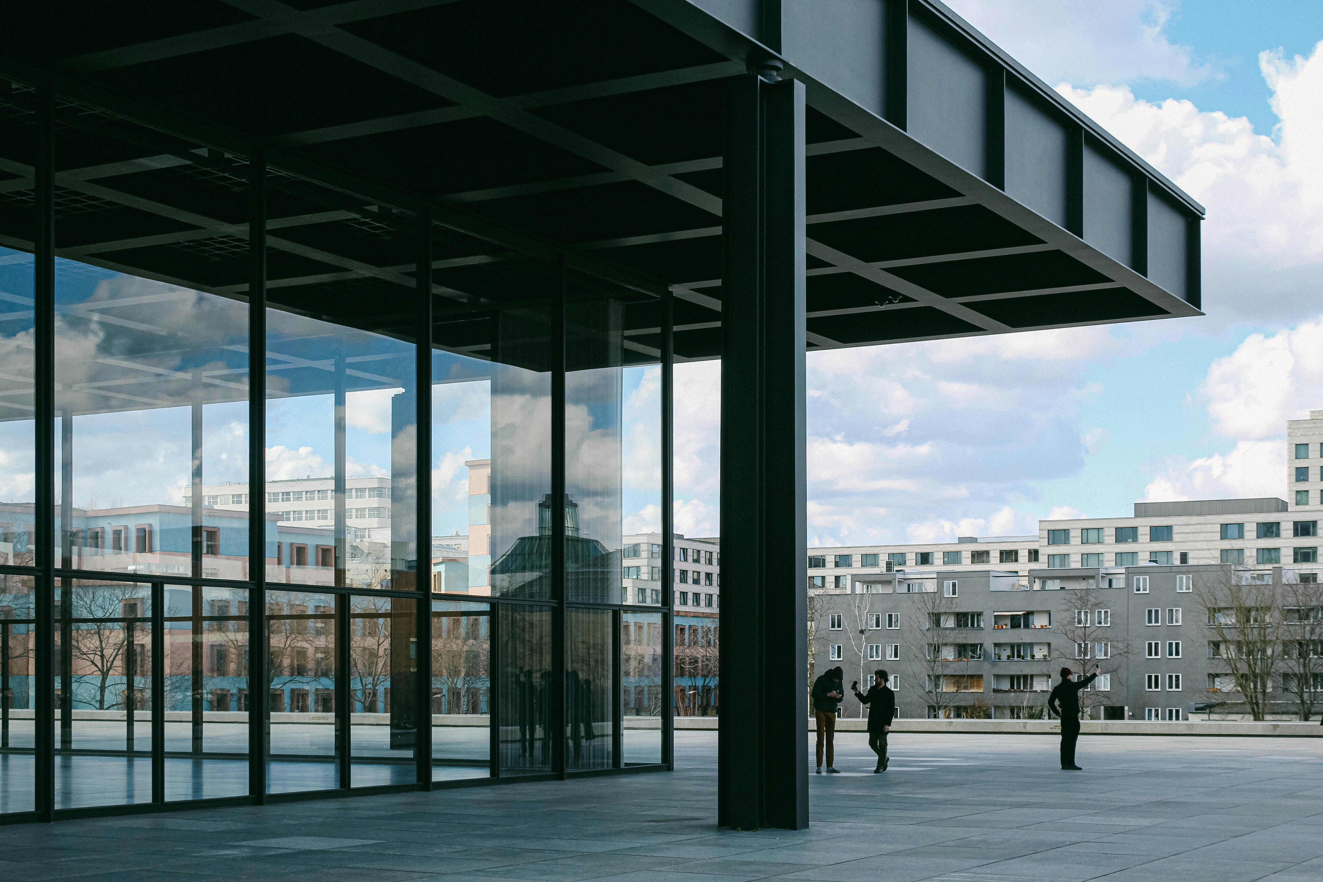 Glass Facade, Quiet Pedestrians: A Minimalist Urban Plaza