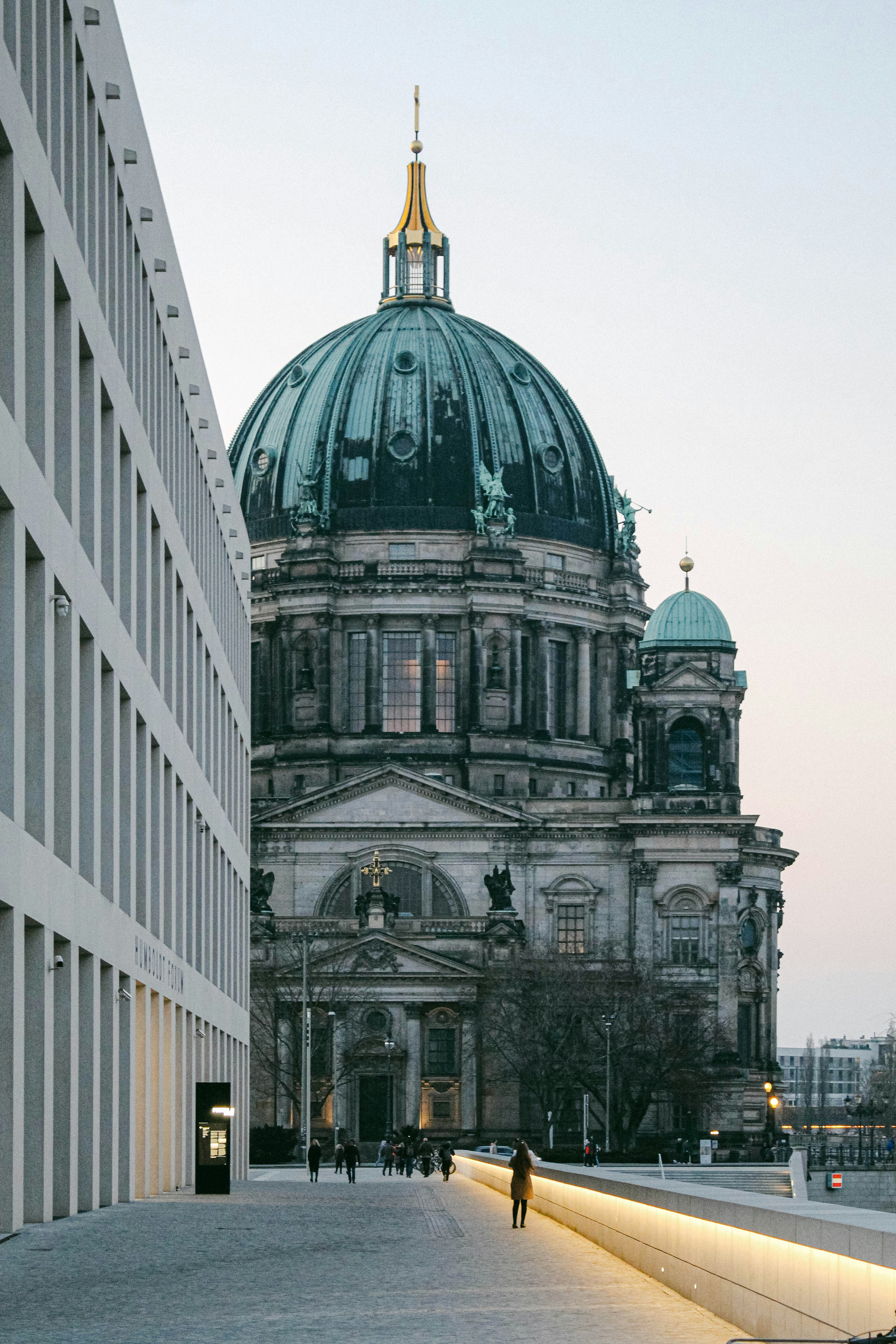 Verdigris Dome Framed by Modern Facades at Dusk