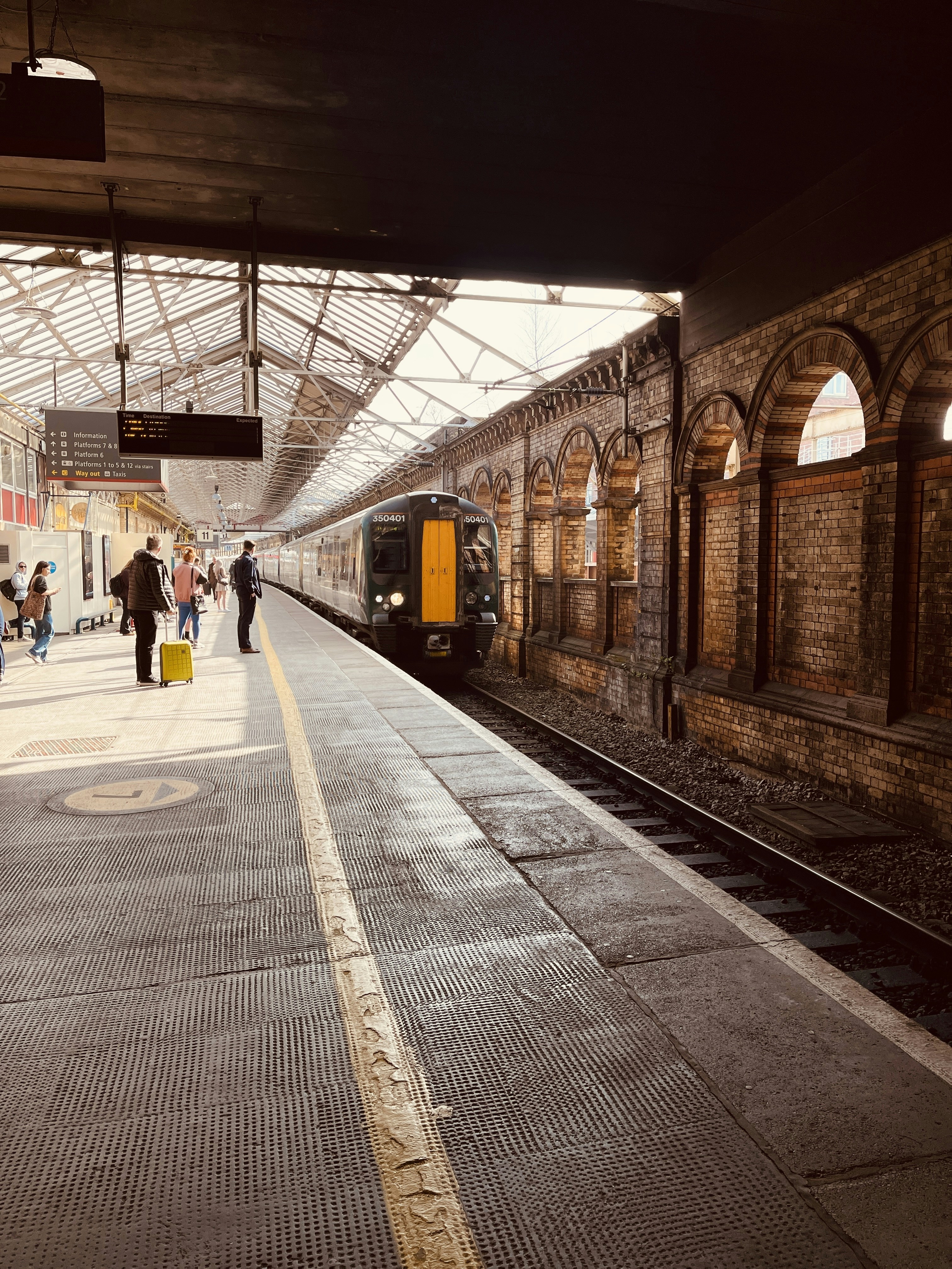 Un train entrant dans une gare à côté d’un quai photo – Photo Gare de ...