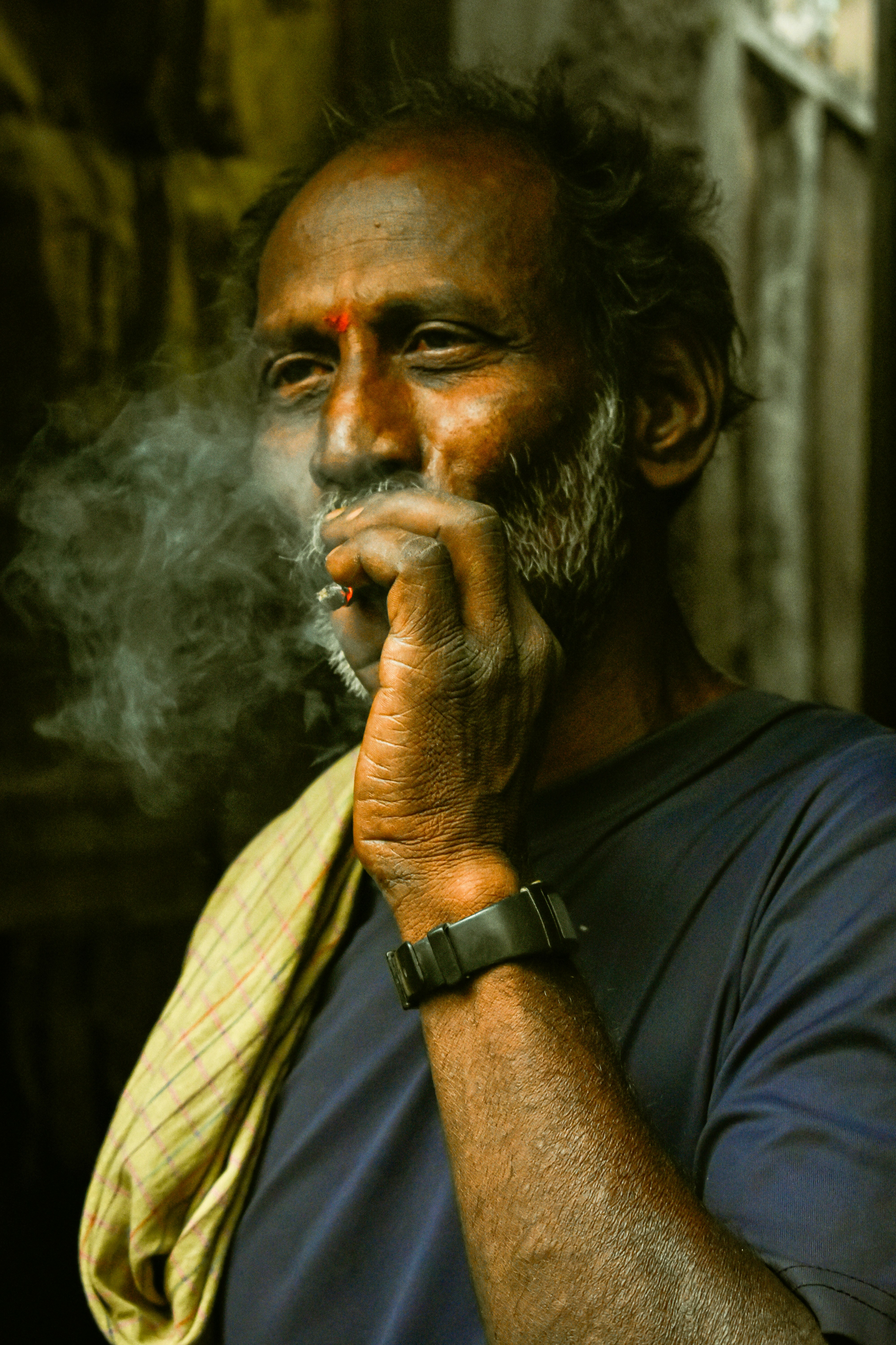 A man with a watch on his wrist smoking a cigarette photo – Free ...