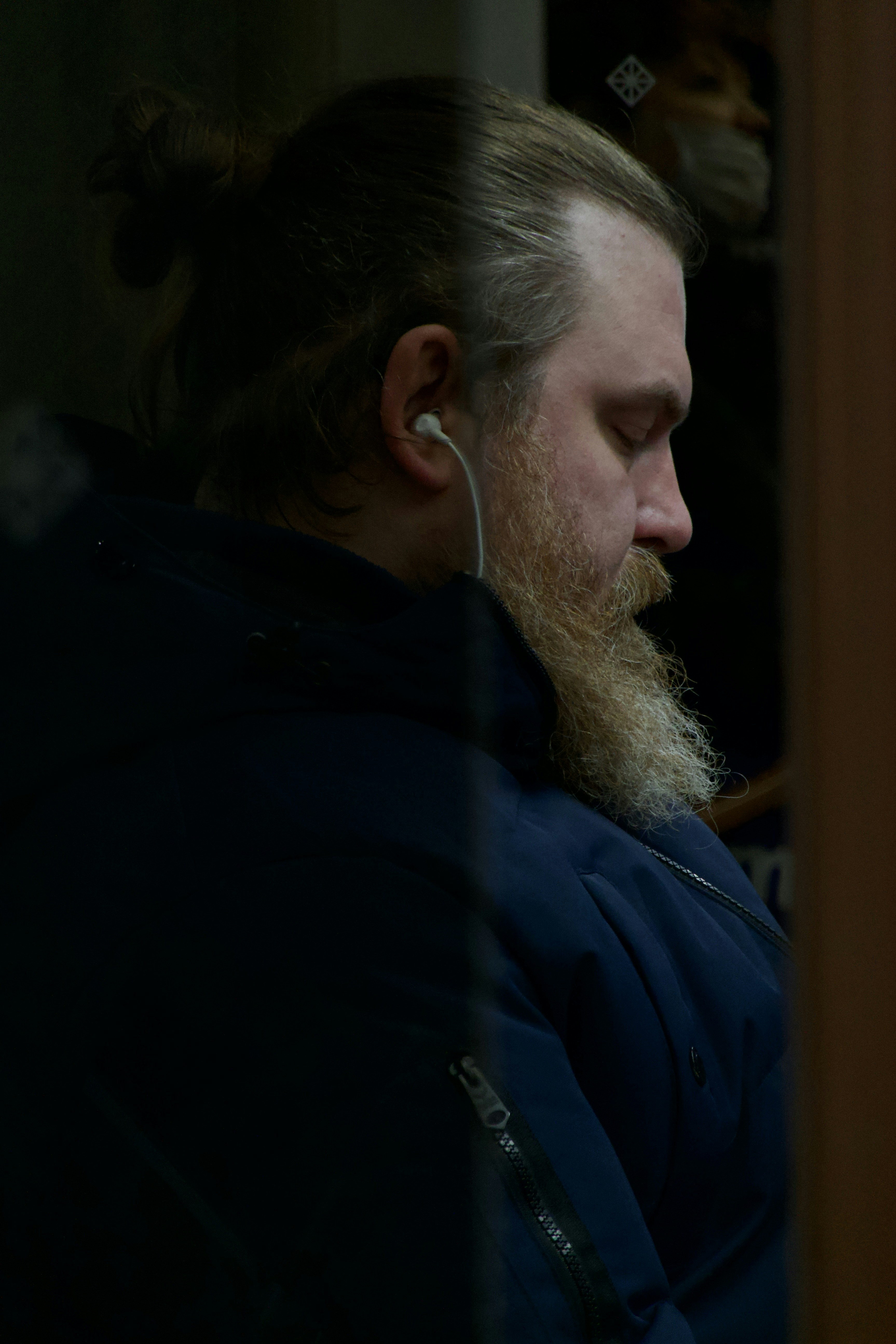 A man with long hair and a beard wearing ear buds photo – Free Portrait ...