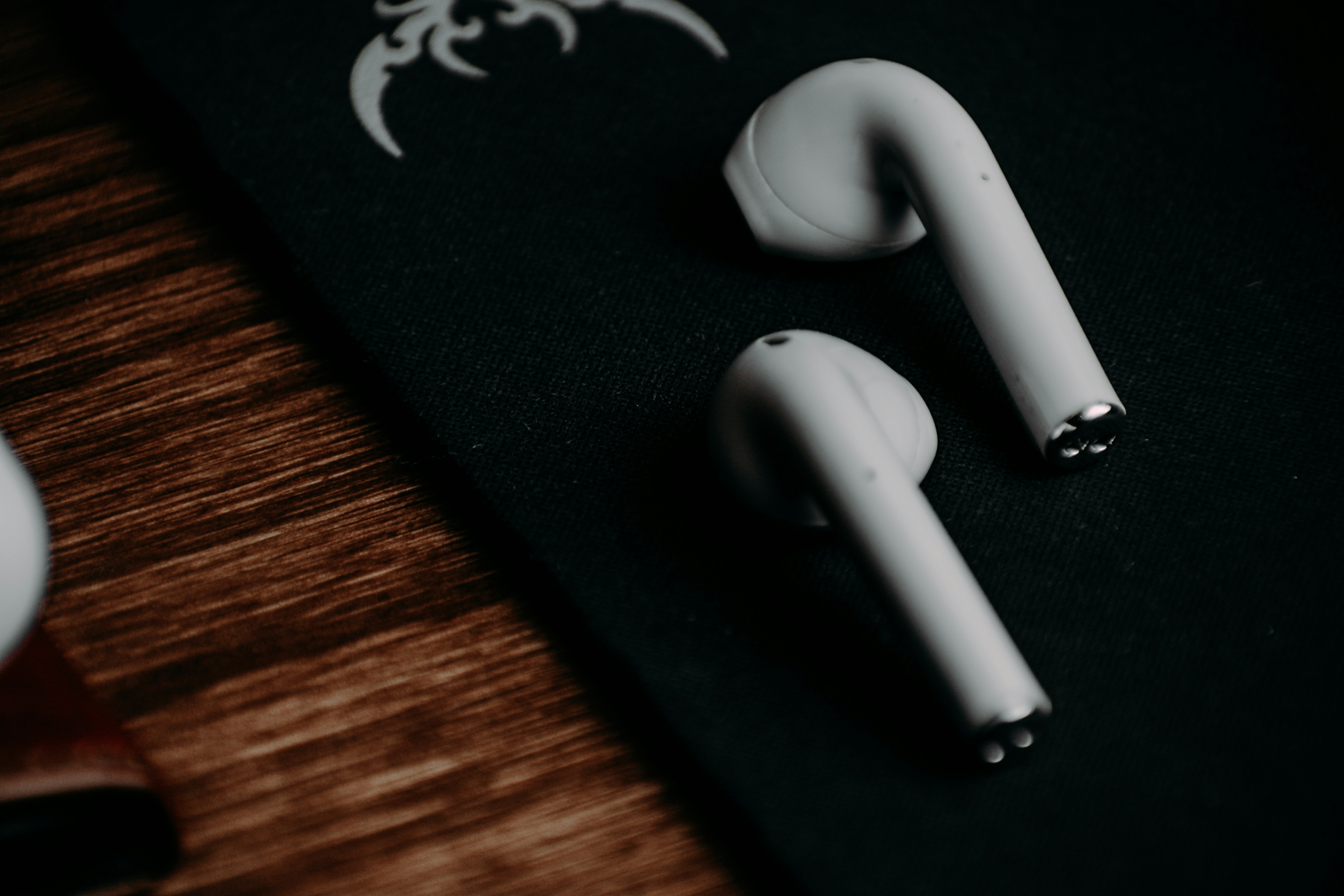A pair of ear buds sitting on top of a table photo – Free Brown Image ...