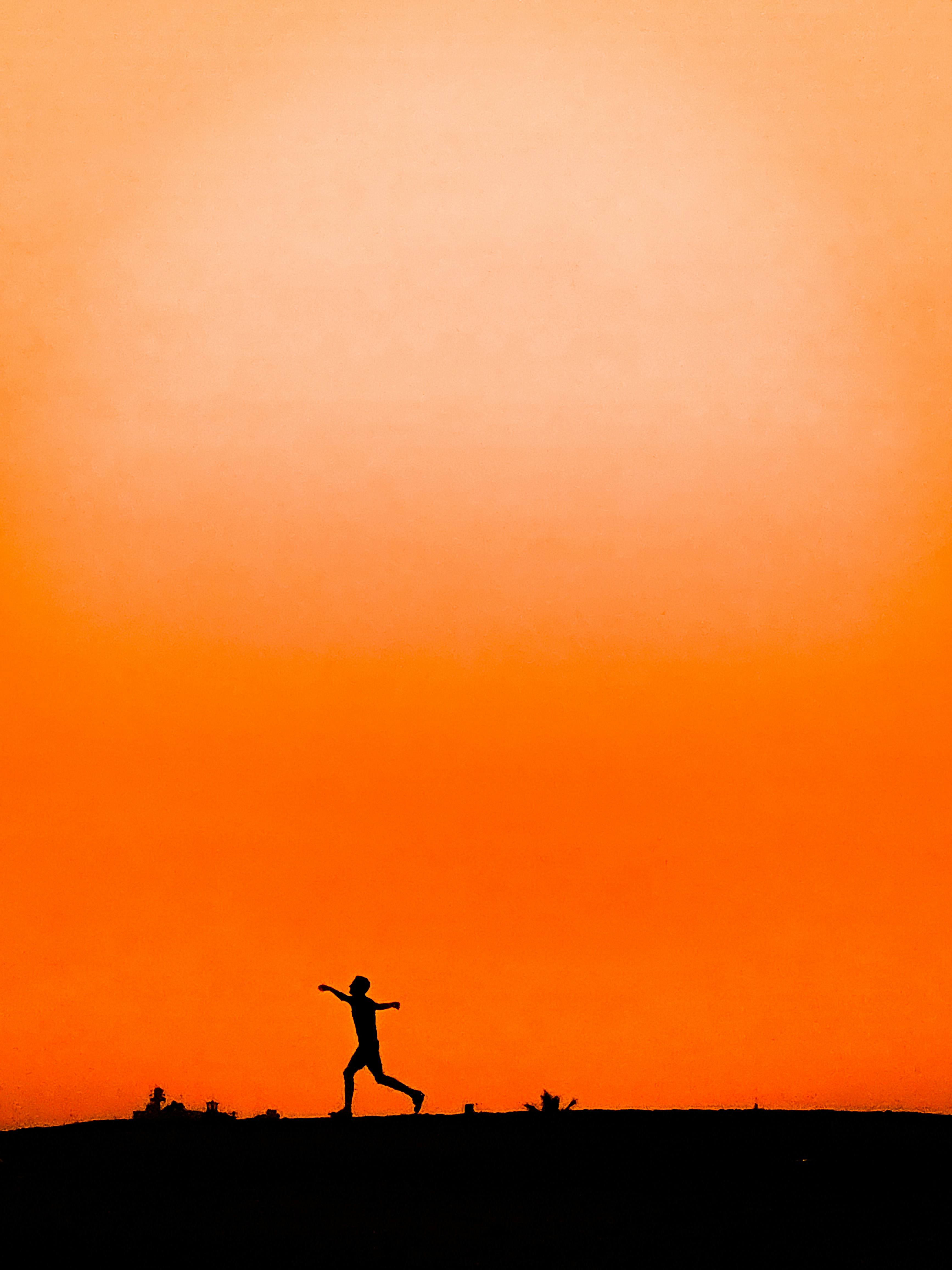 A person running across a field at sunset photo – Free Red Image on ...