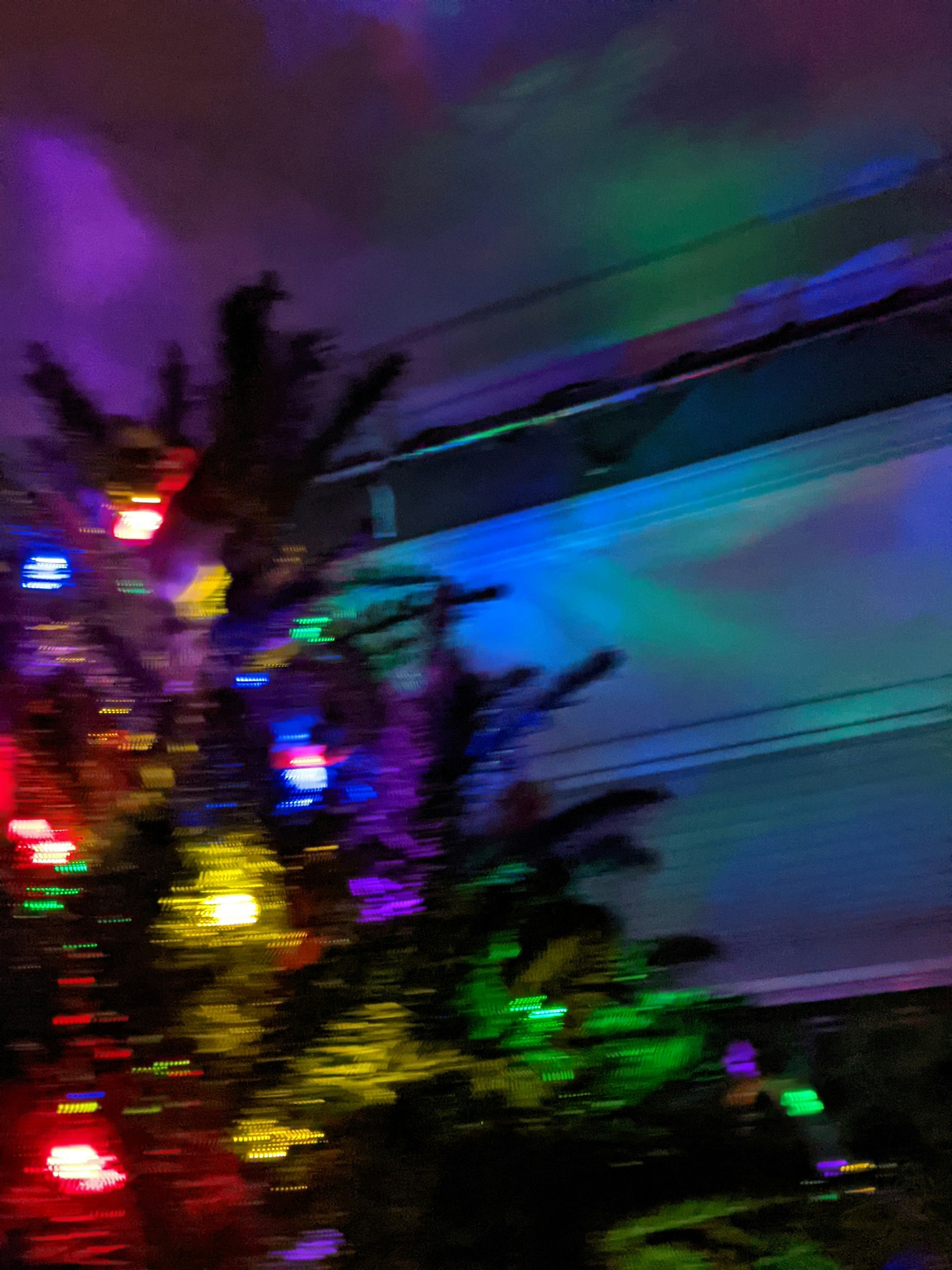 Prismatic Blur: Night Lights Dancing Along a Quiet Street