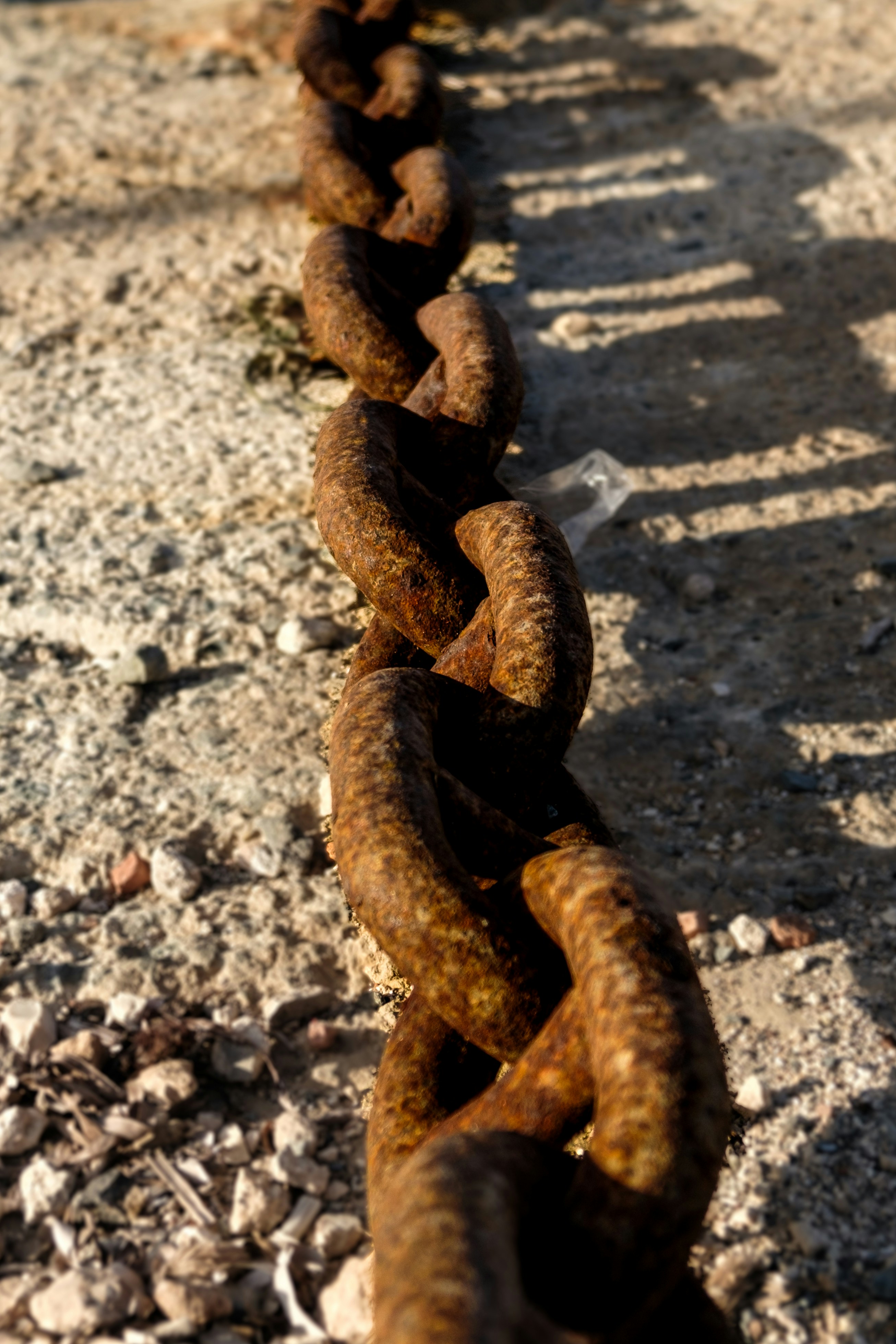 A rusty chain on the side of a road photo – Free Chain Image on Unsplash
