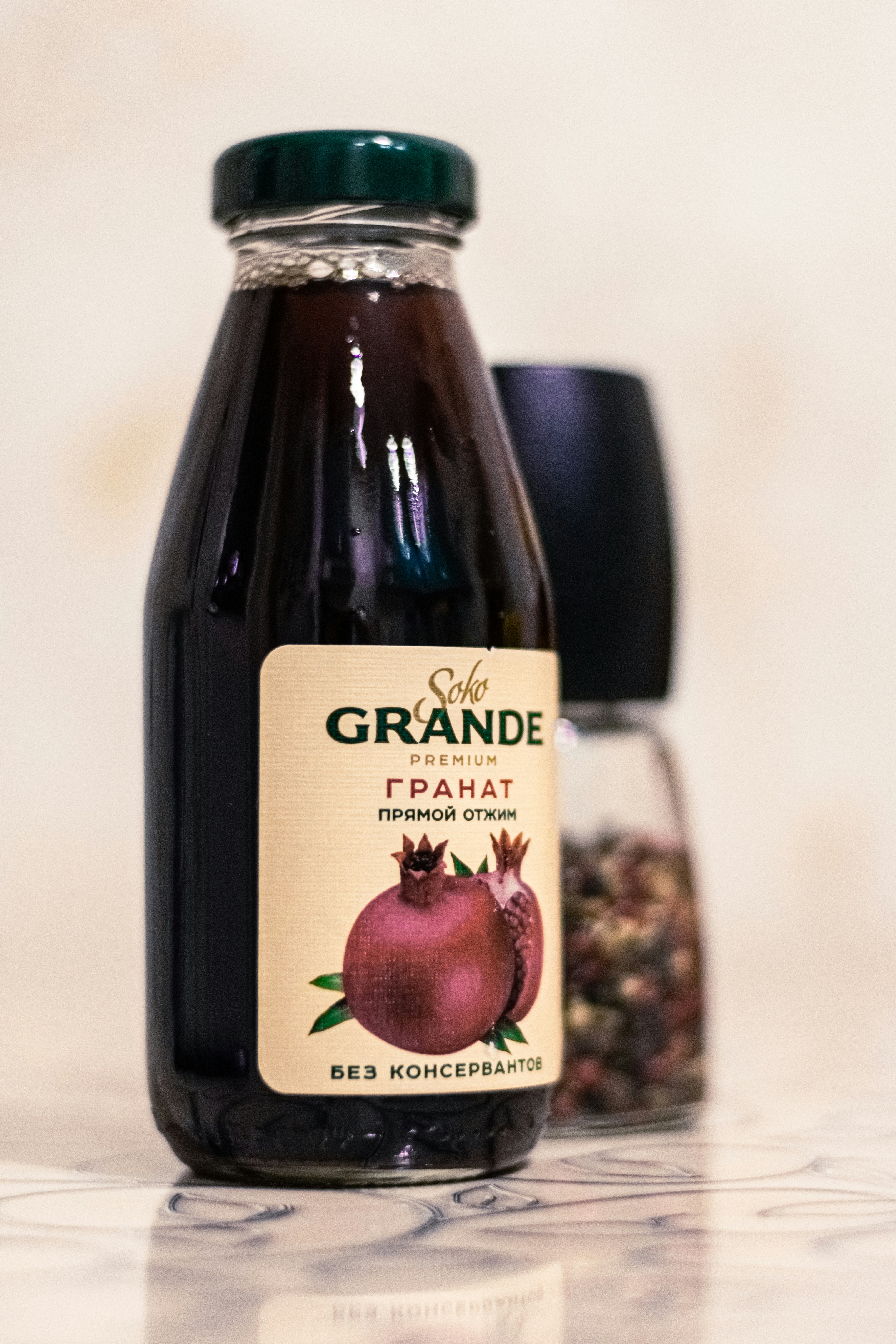Glimmering Granate: A Close-Up of Syrup Bottle with Steam-Blurred Background