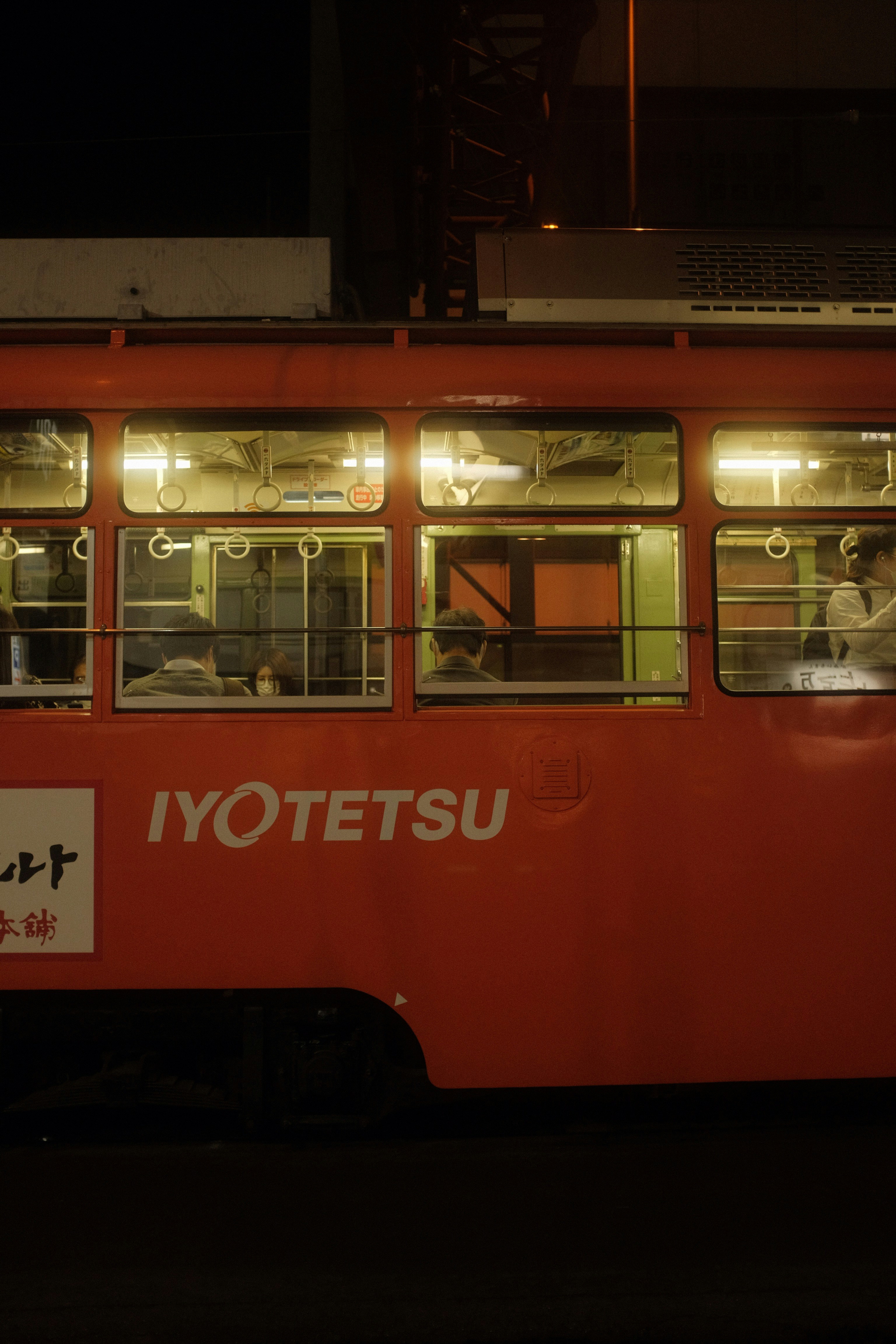 a red train car sitting on top of a street