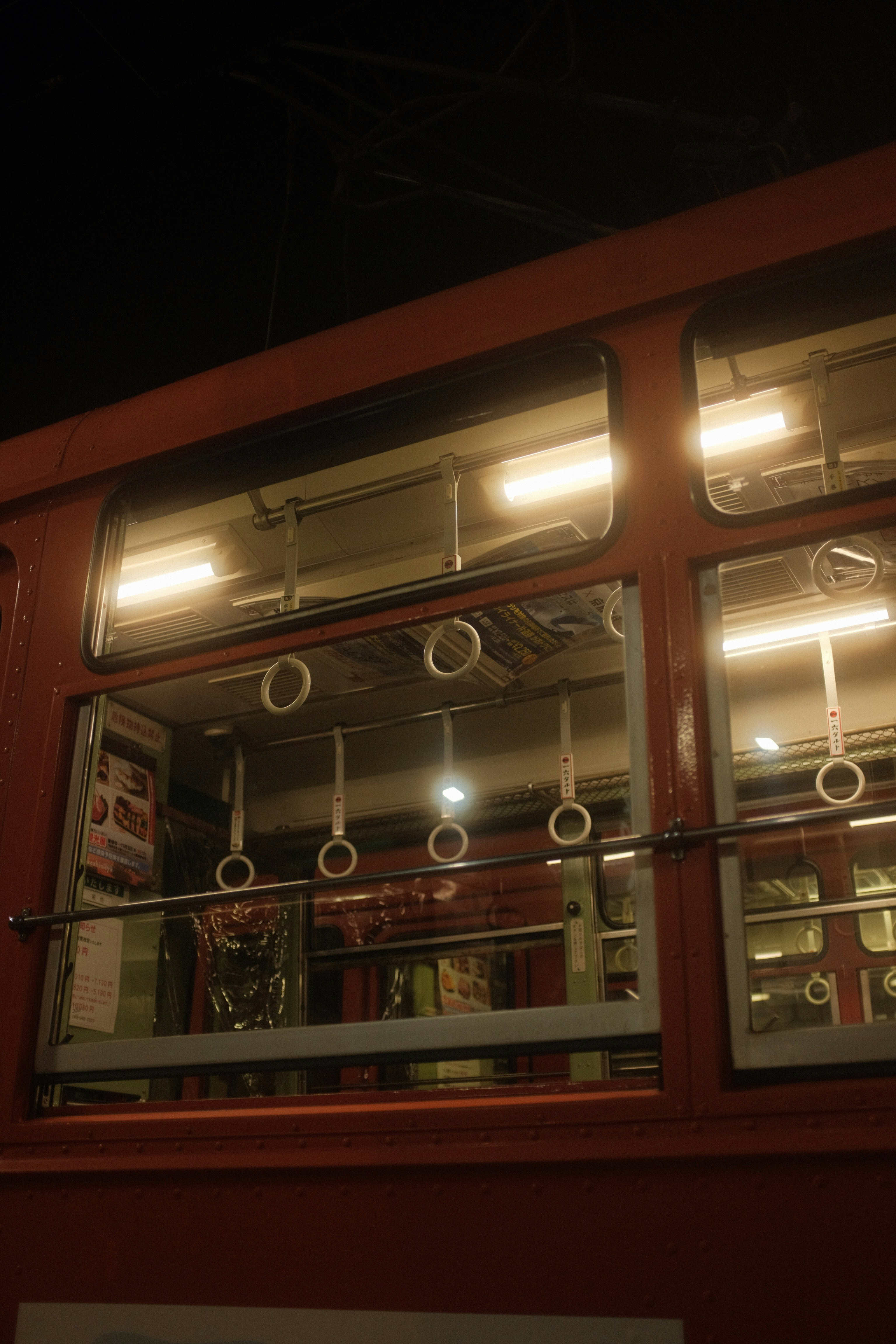Red Streetcar Interior: Circular Handholds Meet Fluorescent Glow