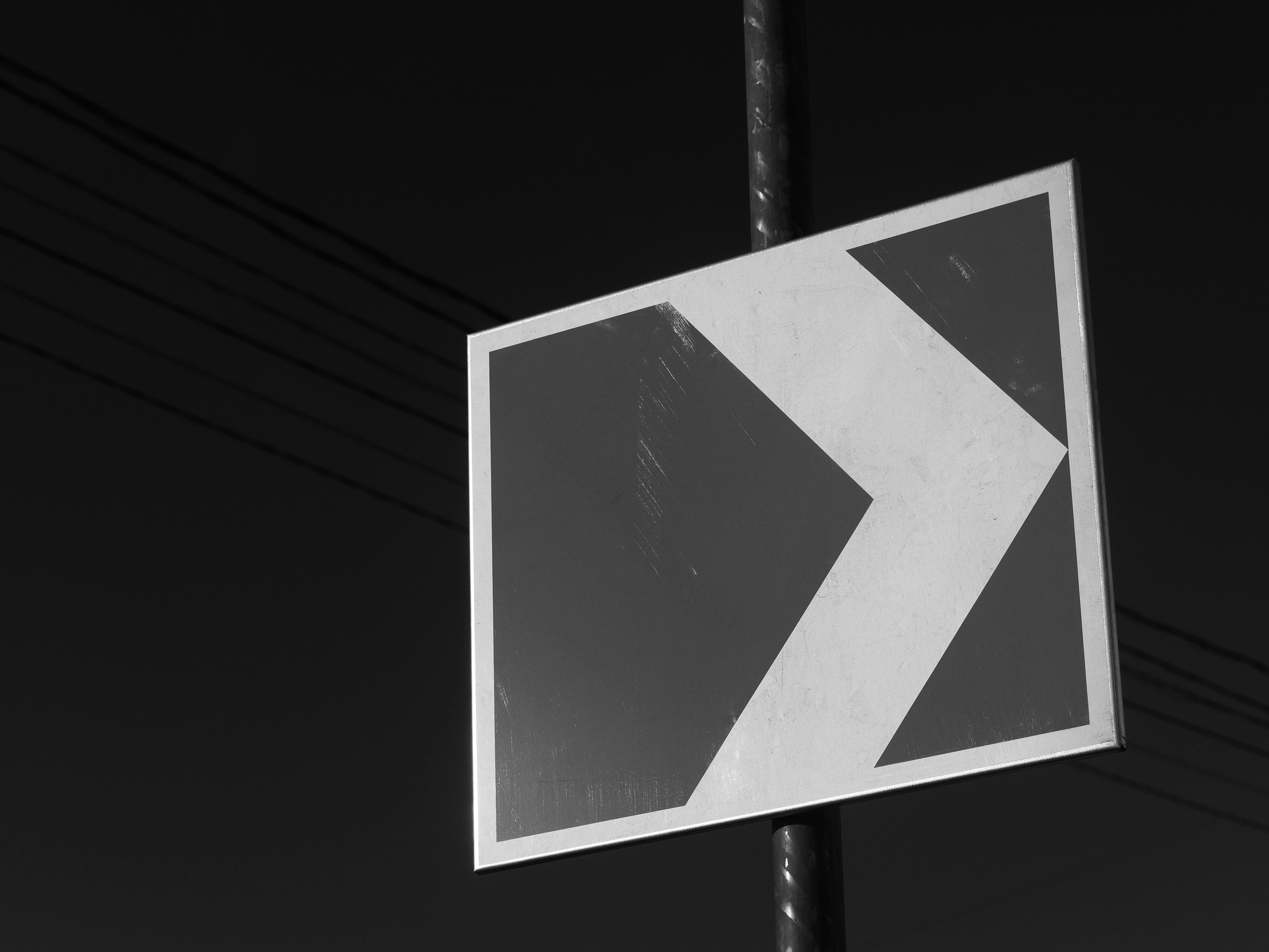 A street sign on a pole with power lines in the background photo – Free ...
