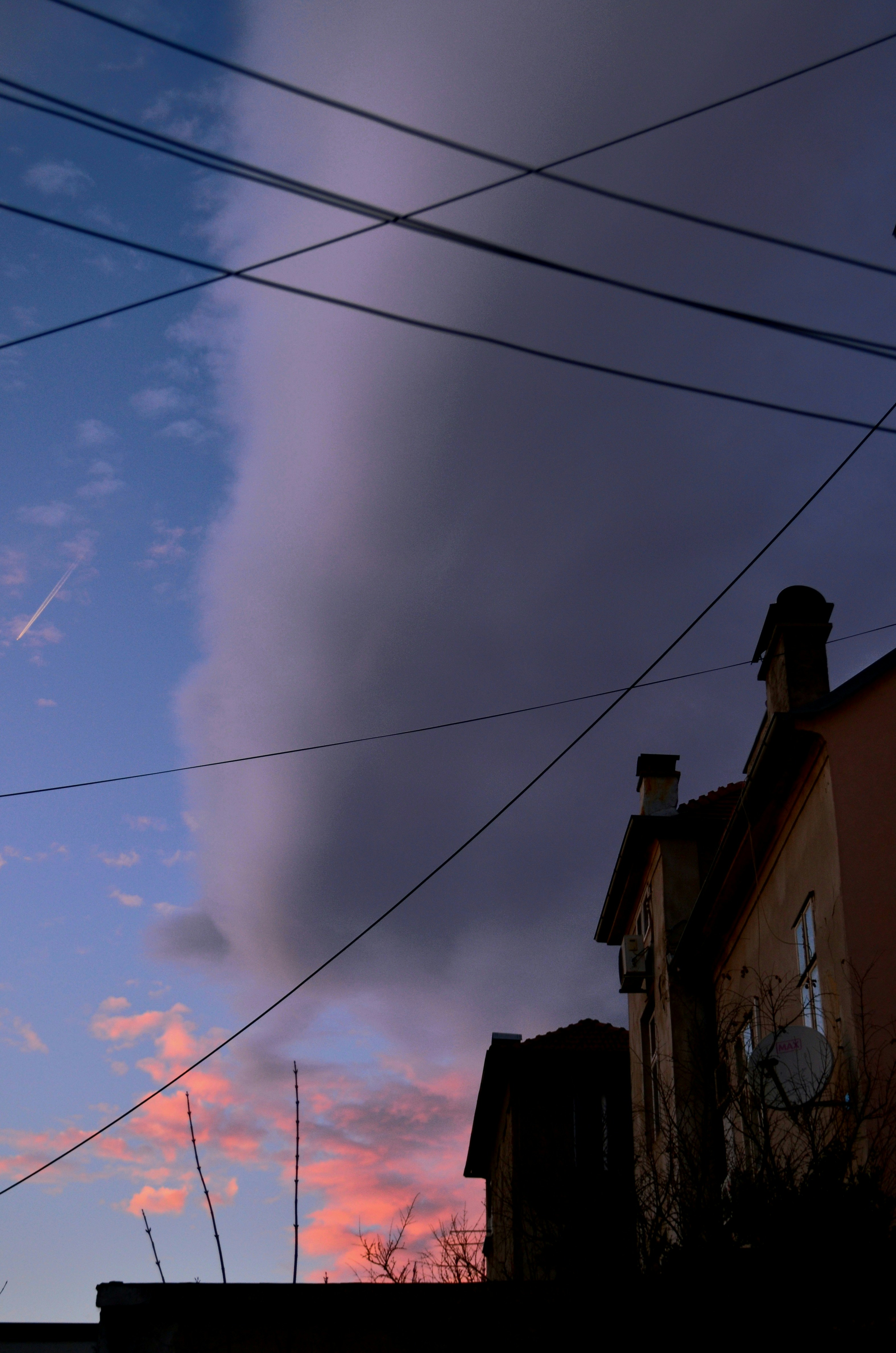 Skyline in Motion: Power Lines Trace a Dusk-to-Dawn Cloud