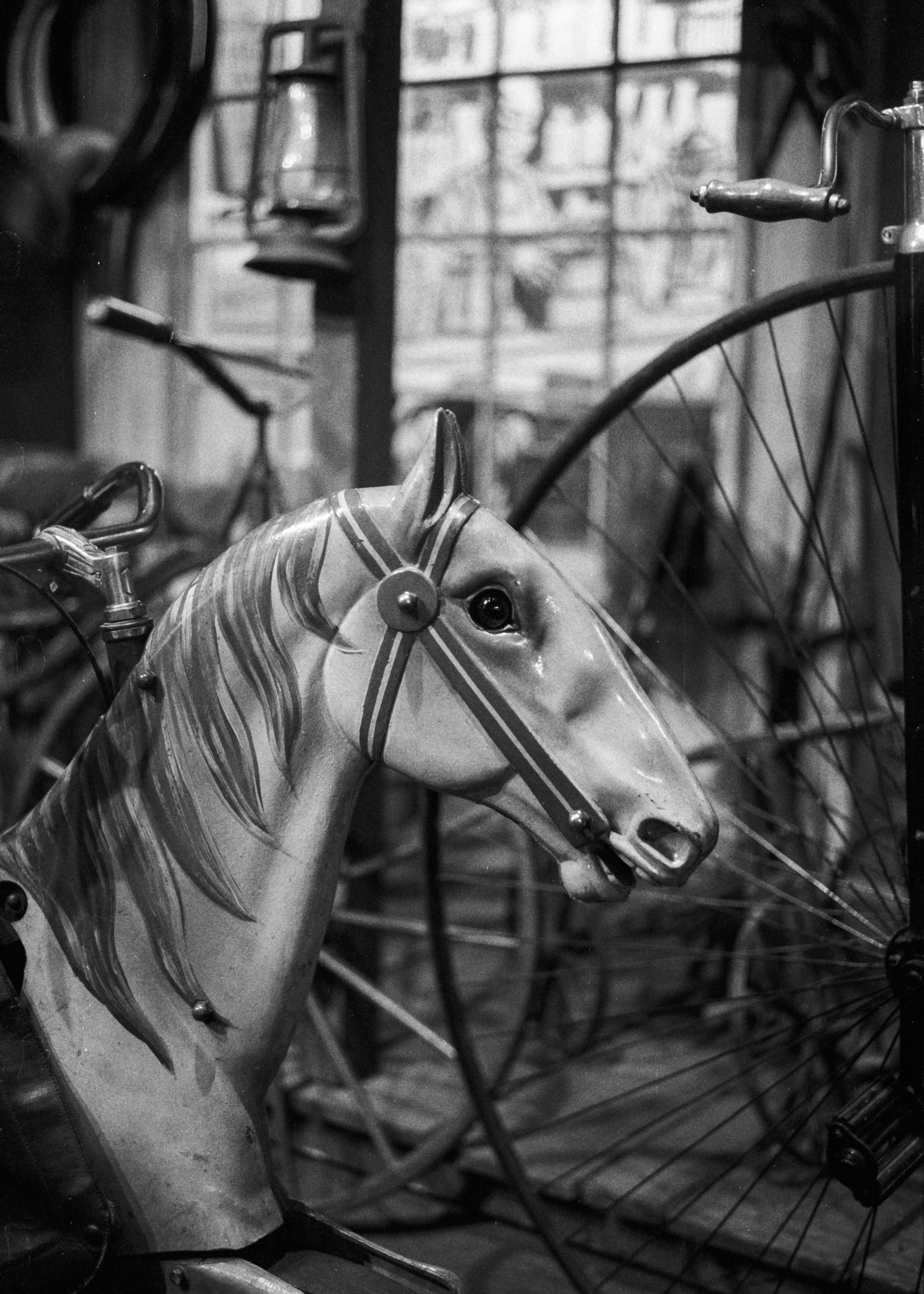 a black and white photo of a carousel horse