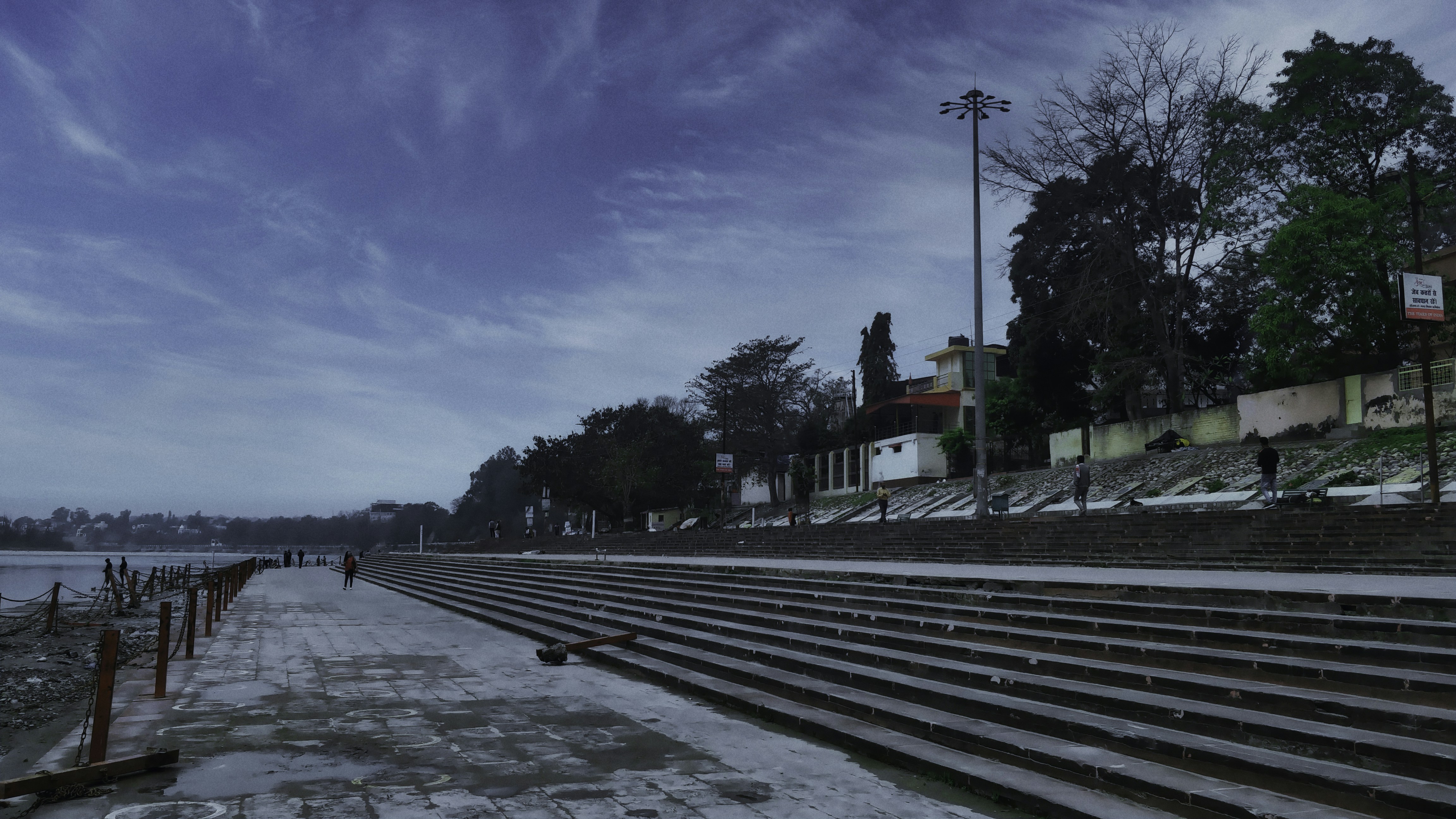 A row of seats sitting next to a body of water photo – Free Ganga nagar ...