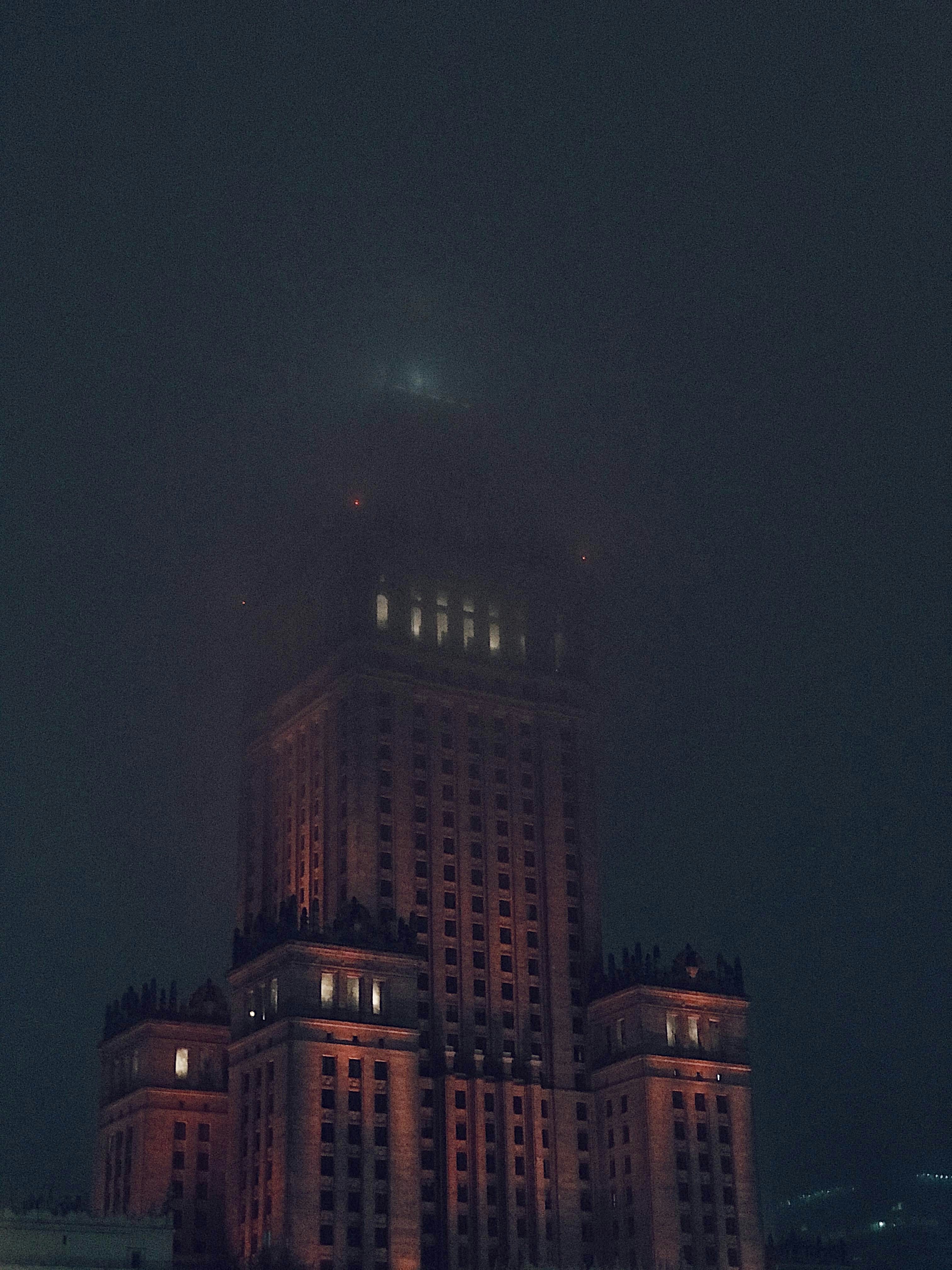 Amber-spired Night: The Tower Rising Through Mist