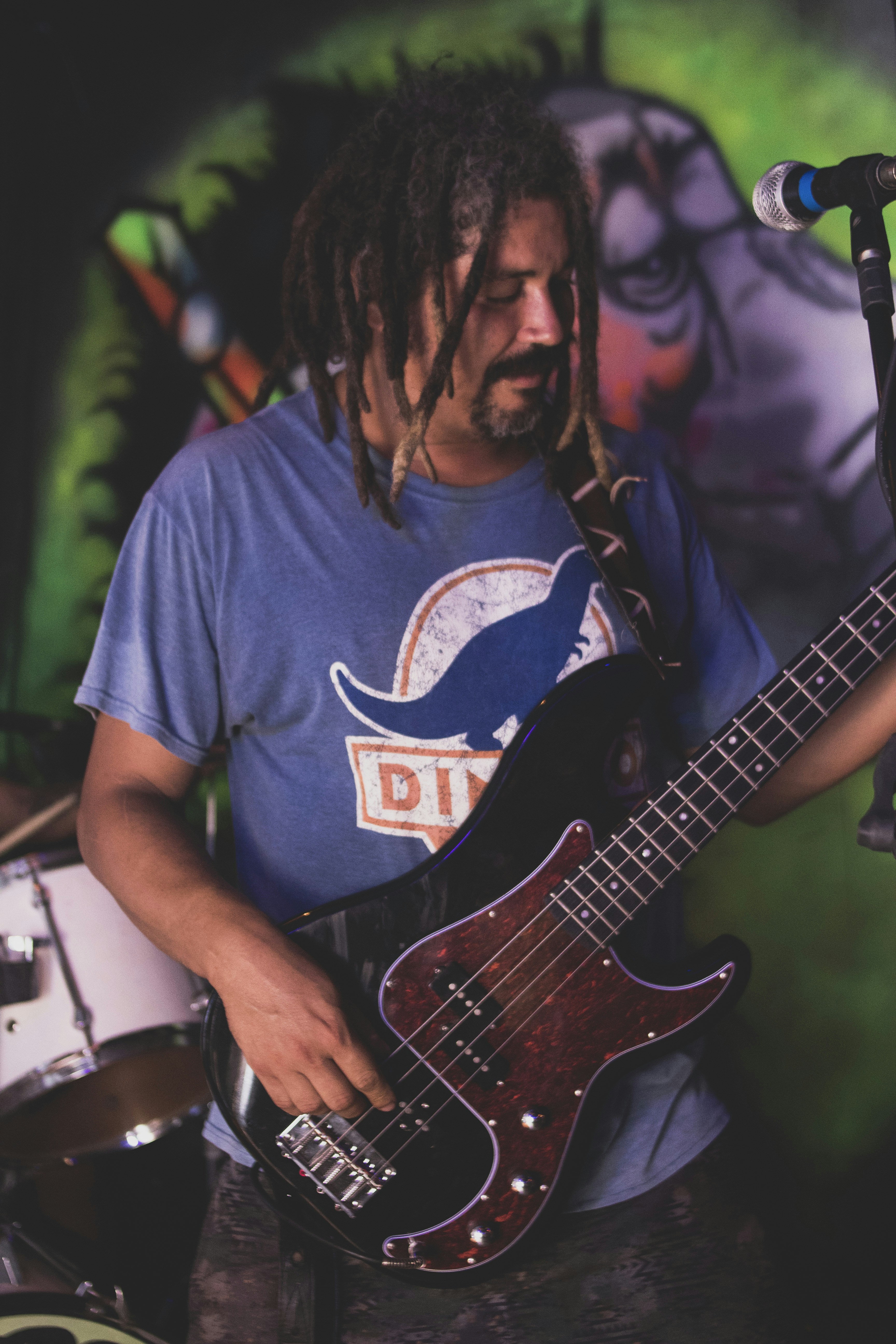 Groove in the Spotlight: Bassist Mid‑Performance Under Neon Backdrop