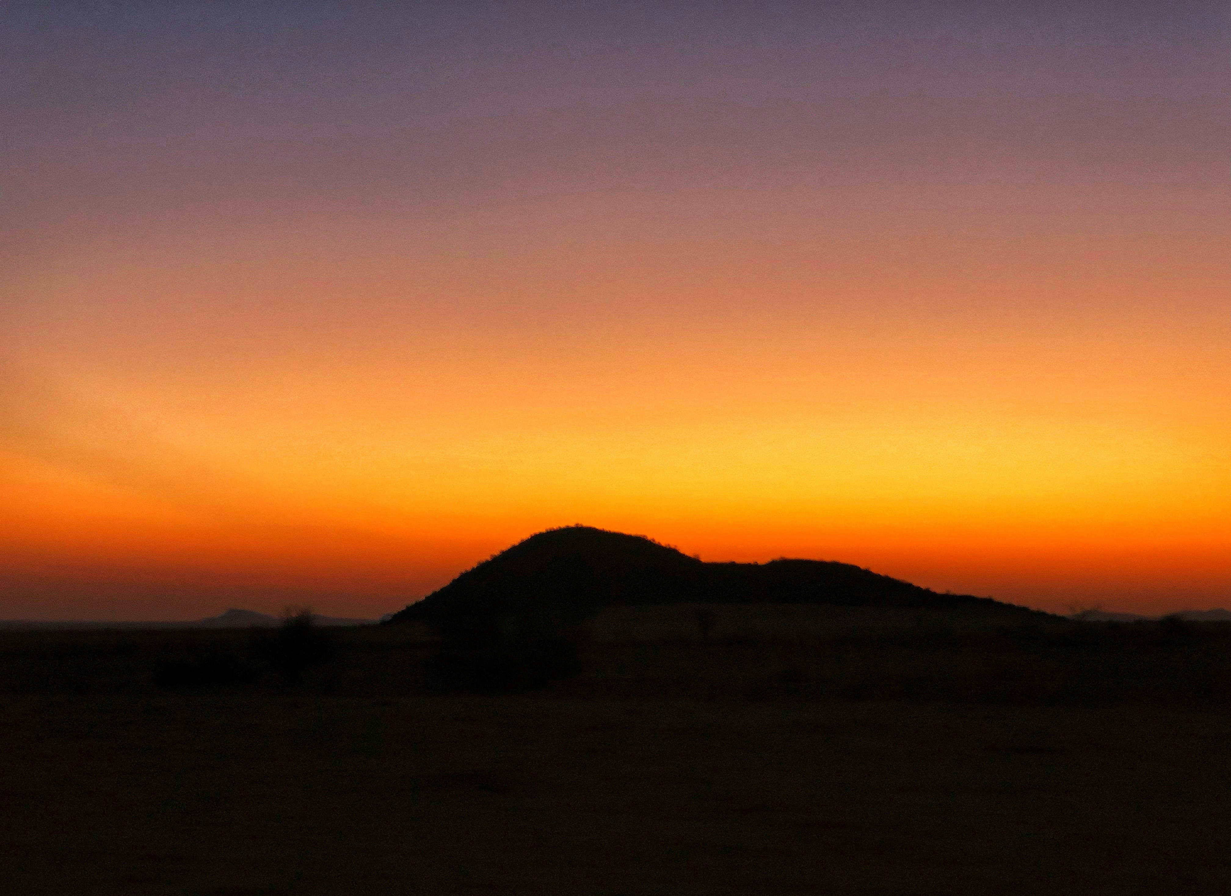 The sun is setting over a hill in the desert photo – Free Hardap region ...