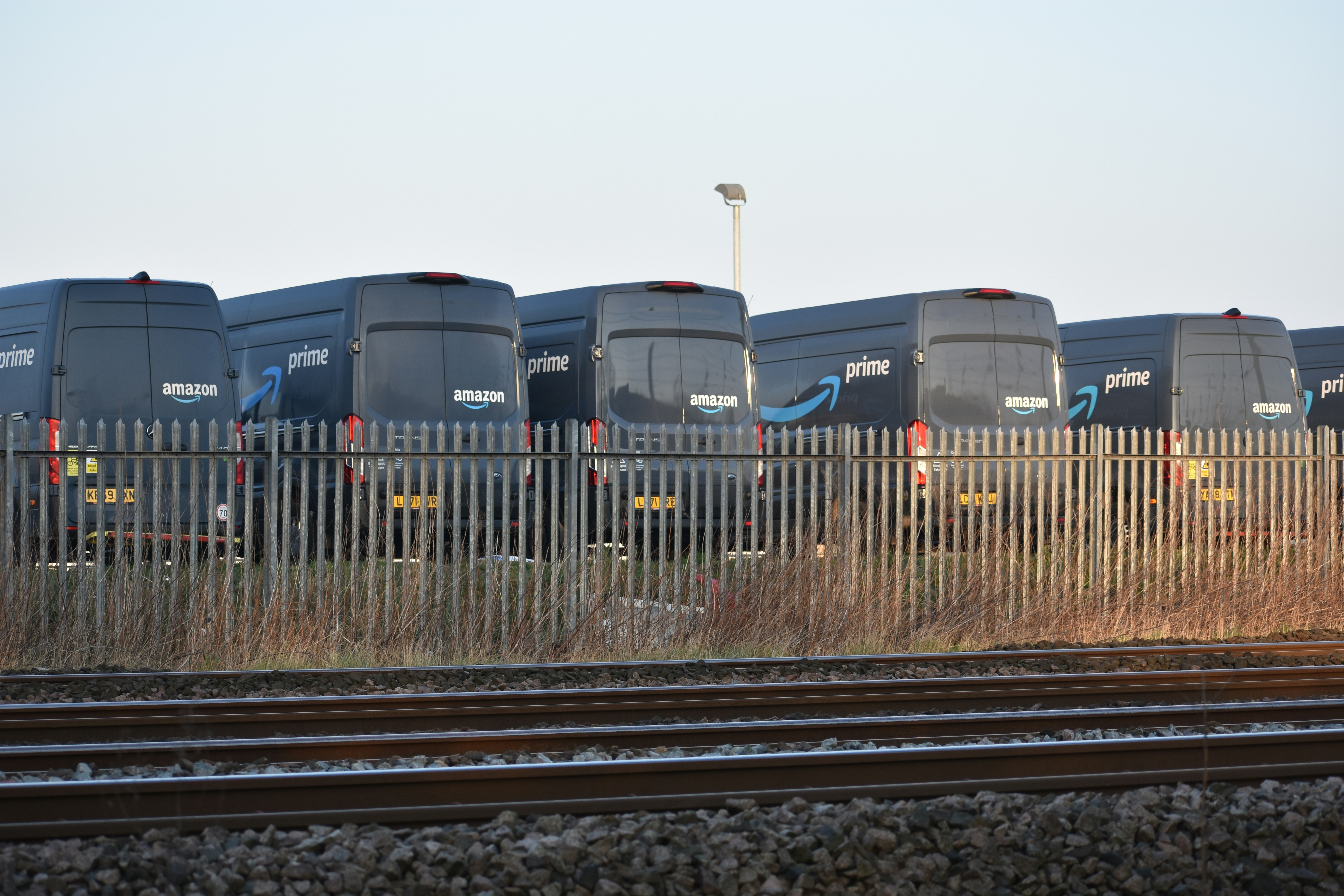 Vans parked beside a railway line