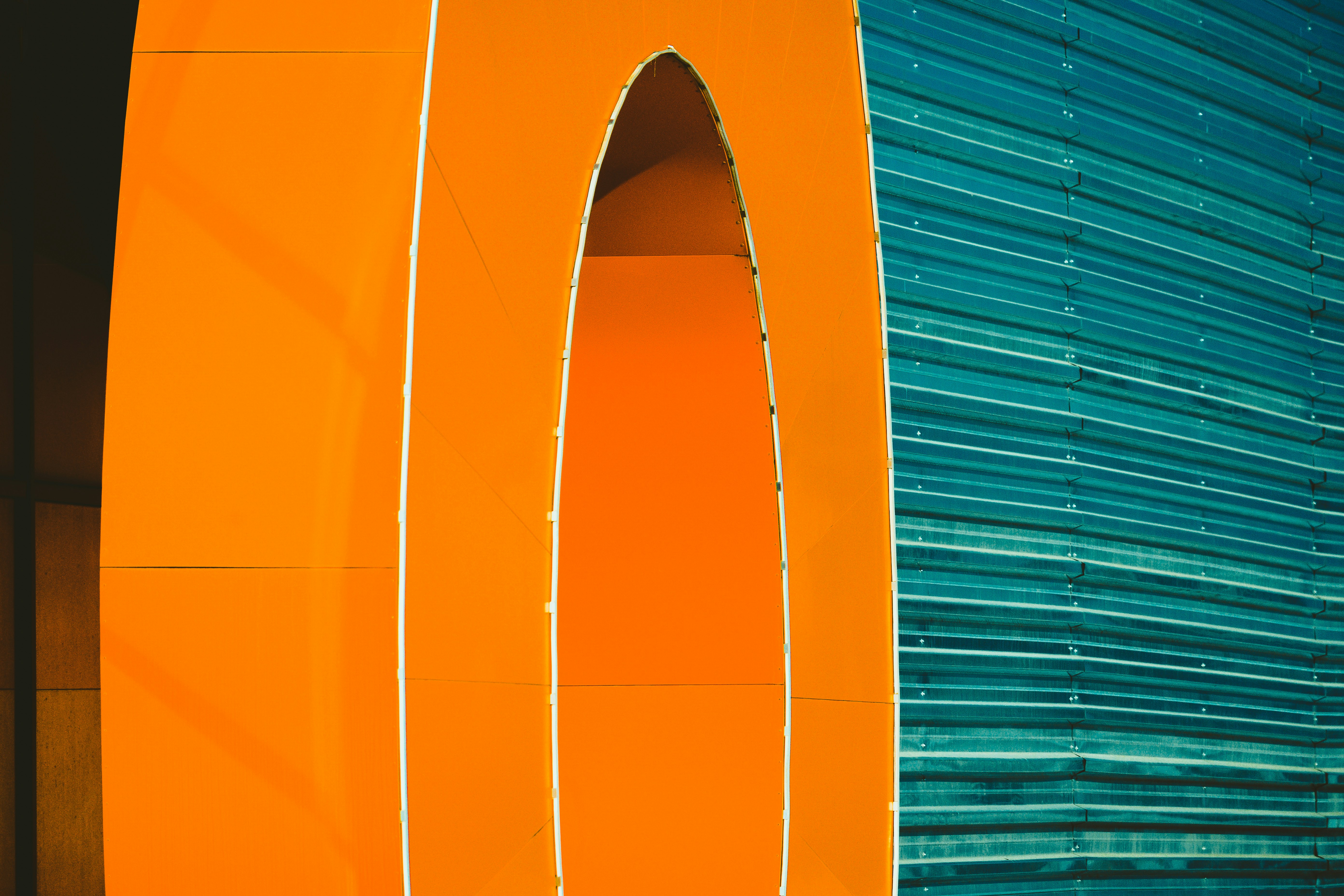A close up of a large orange object near a building photo – Free Orange ...