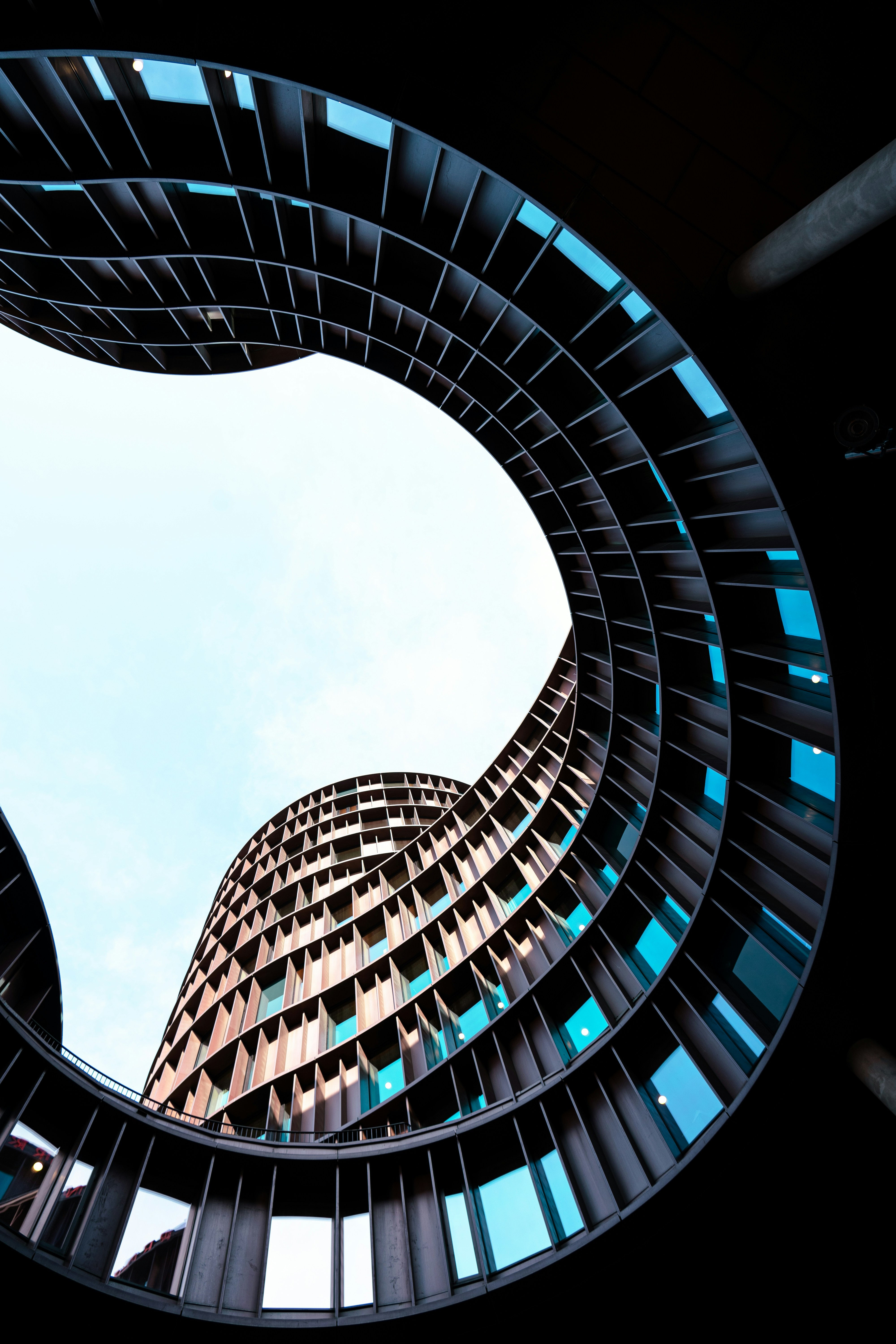 Looking up at a tall building through a circular window photo – Free ...