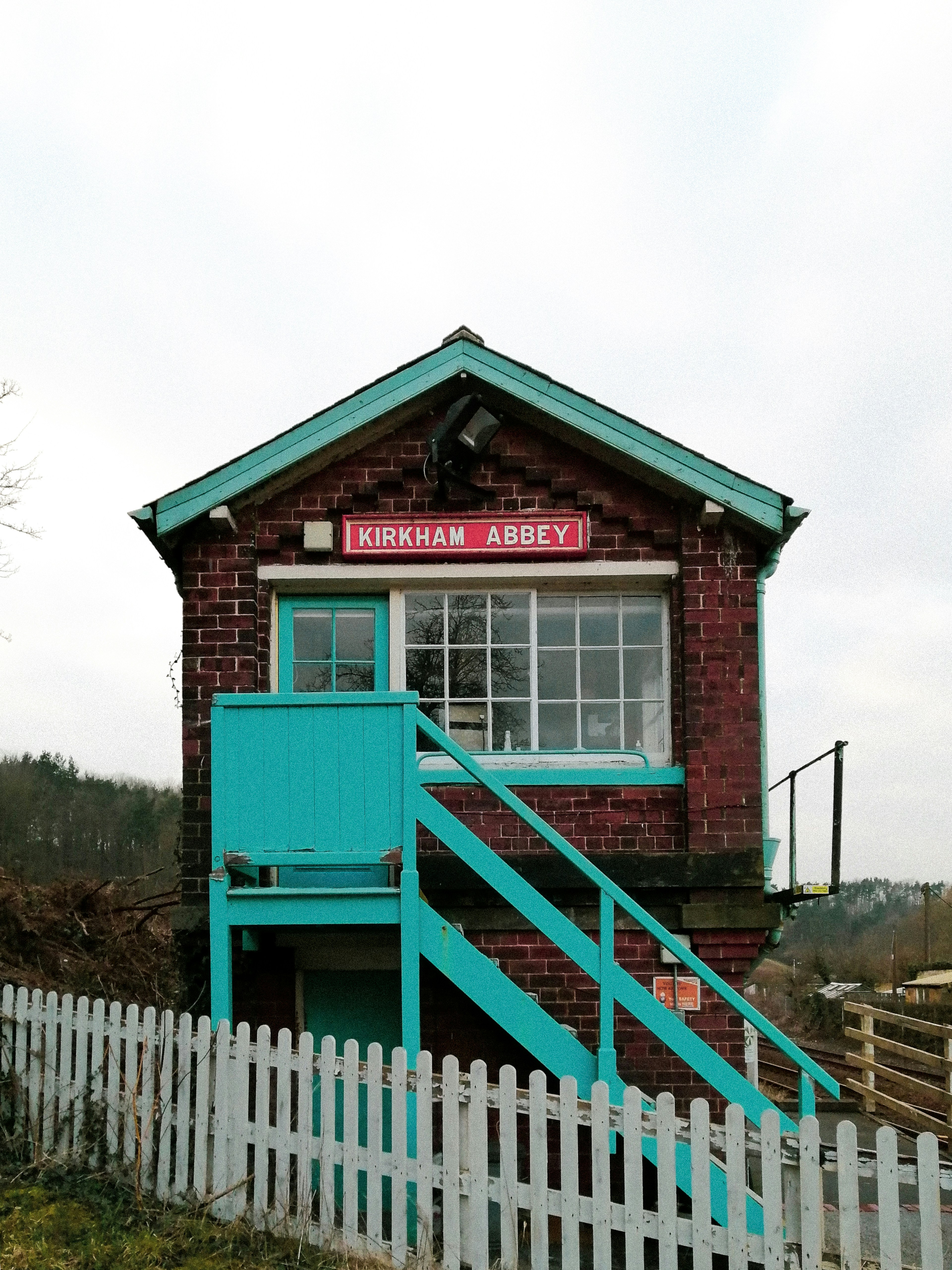 A red brick building with a white picket fence photo – Free Kirkham ...