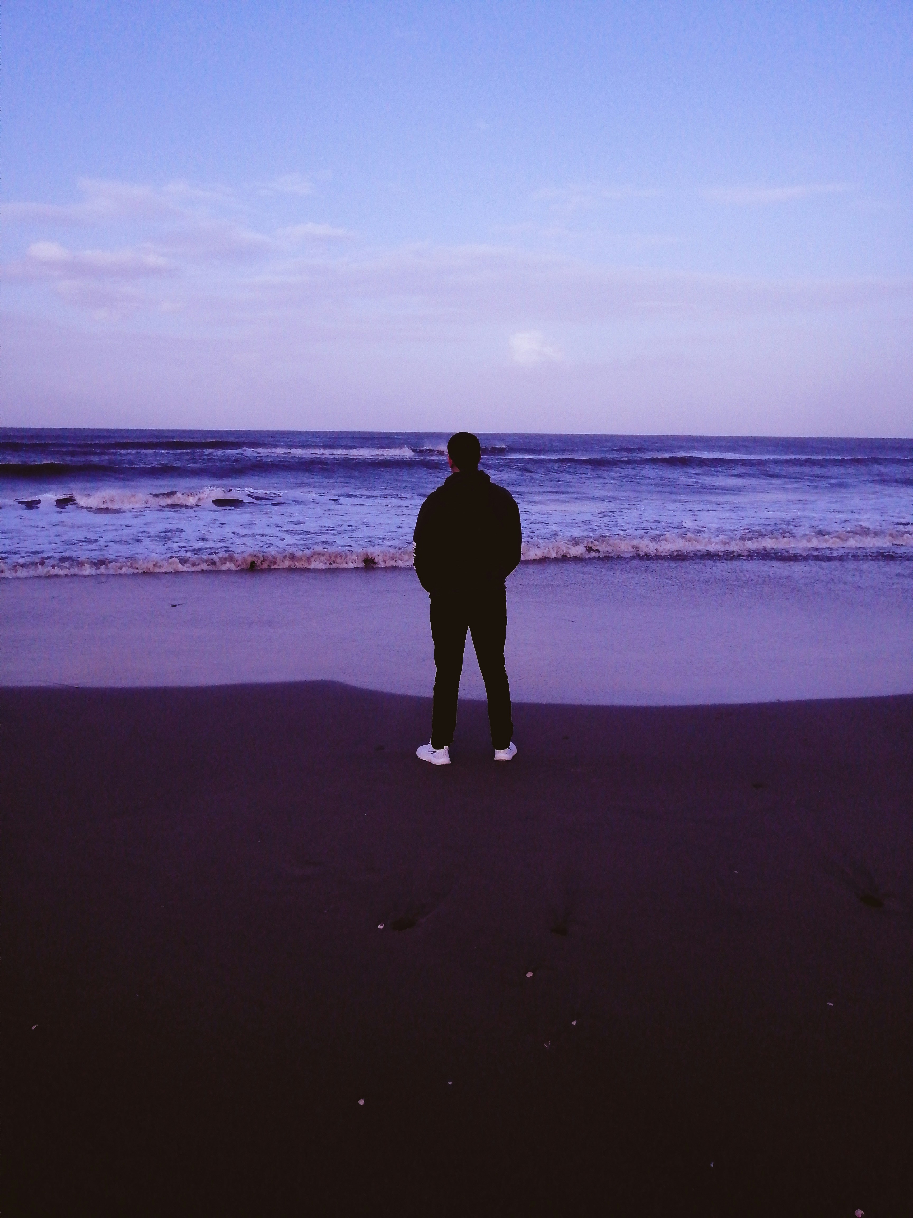 Man Standing Alone On Beach