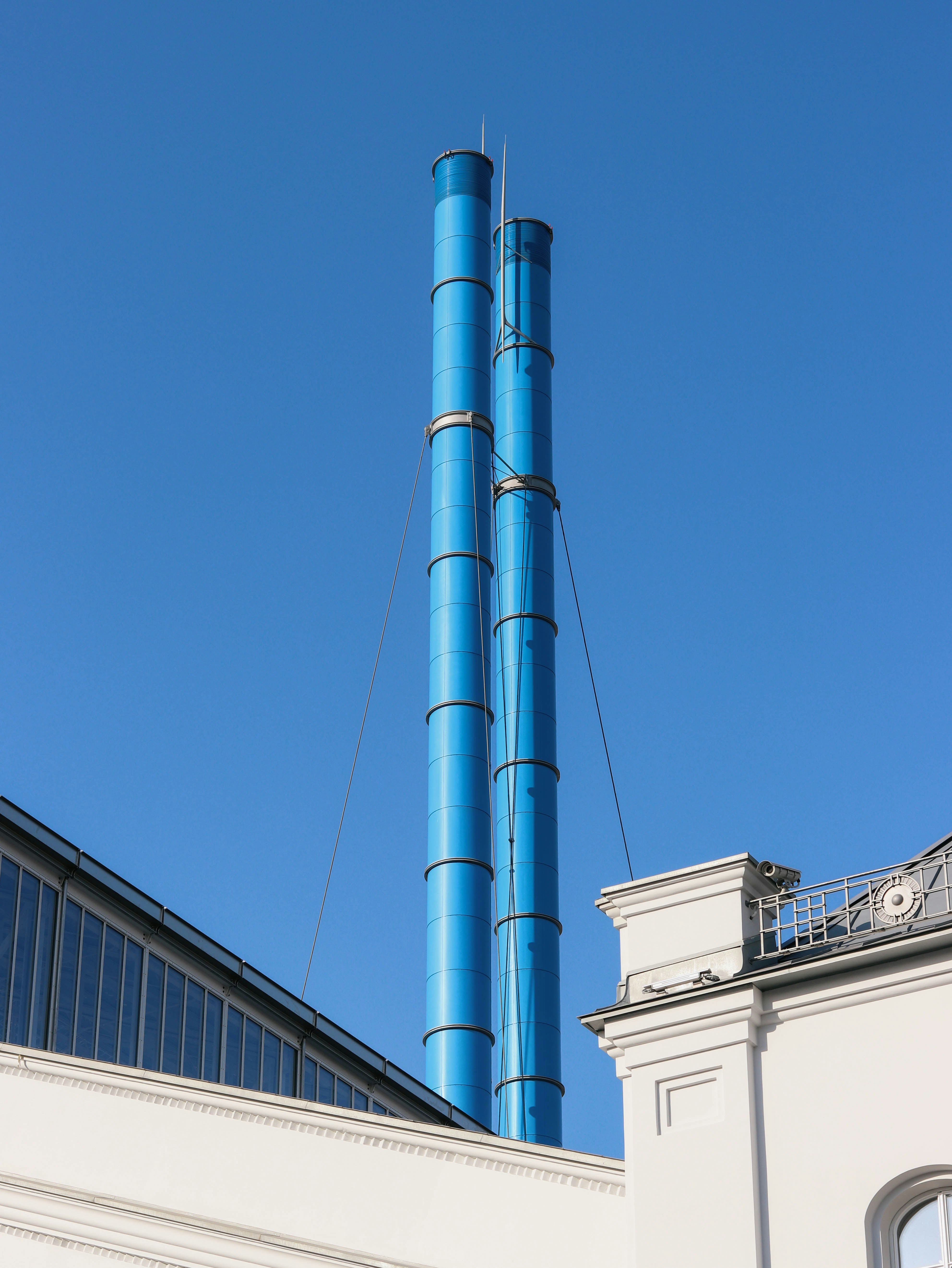 Azure Chimney Towers Rise Over a Classical Rooftop