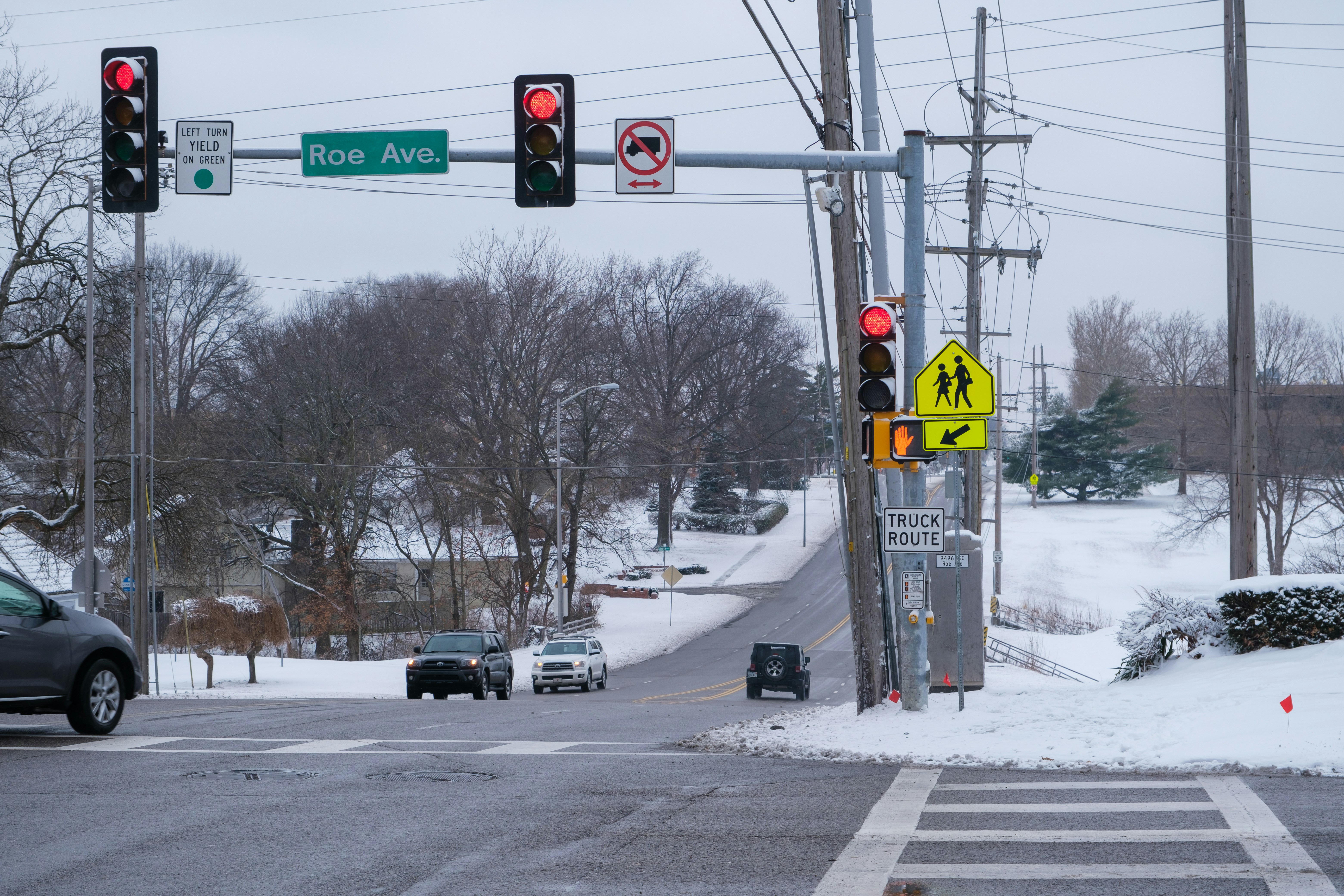 Roe Ave Crossing: Red Signals and Snowy Suburban Silence