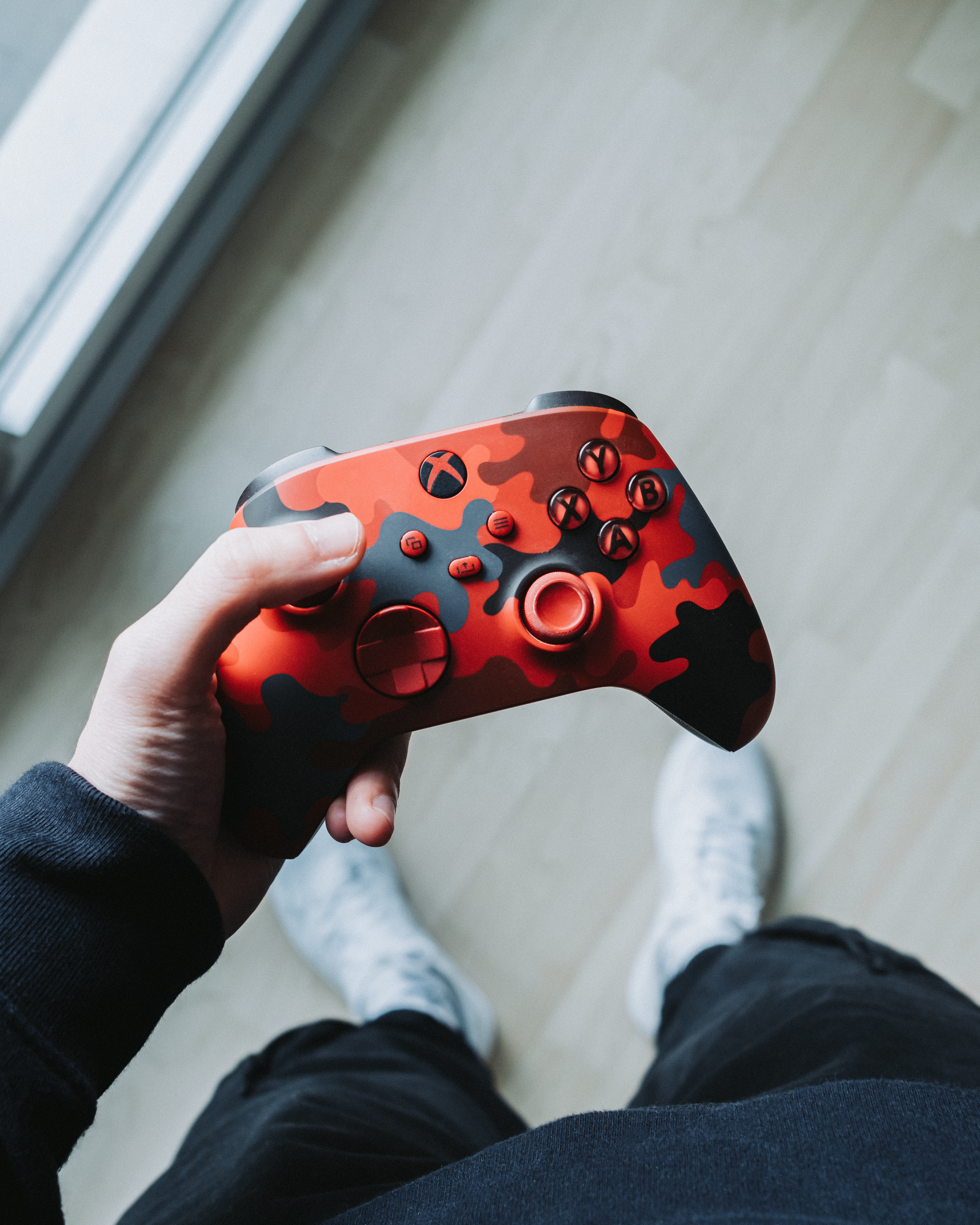 A person holding a red and black controller photo – Free España Image ...