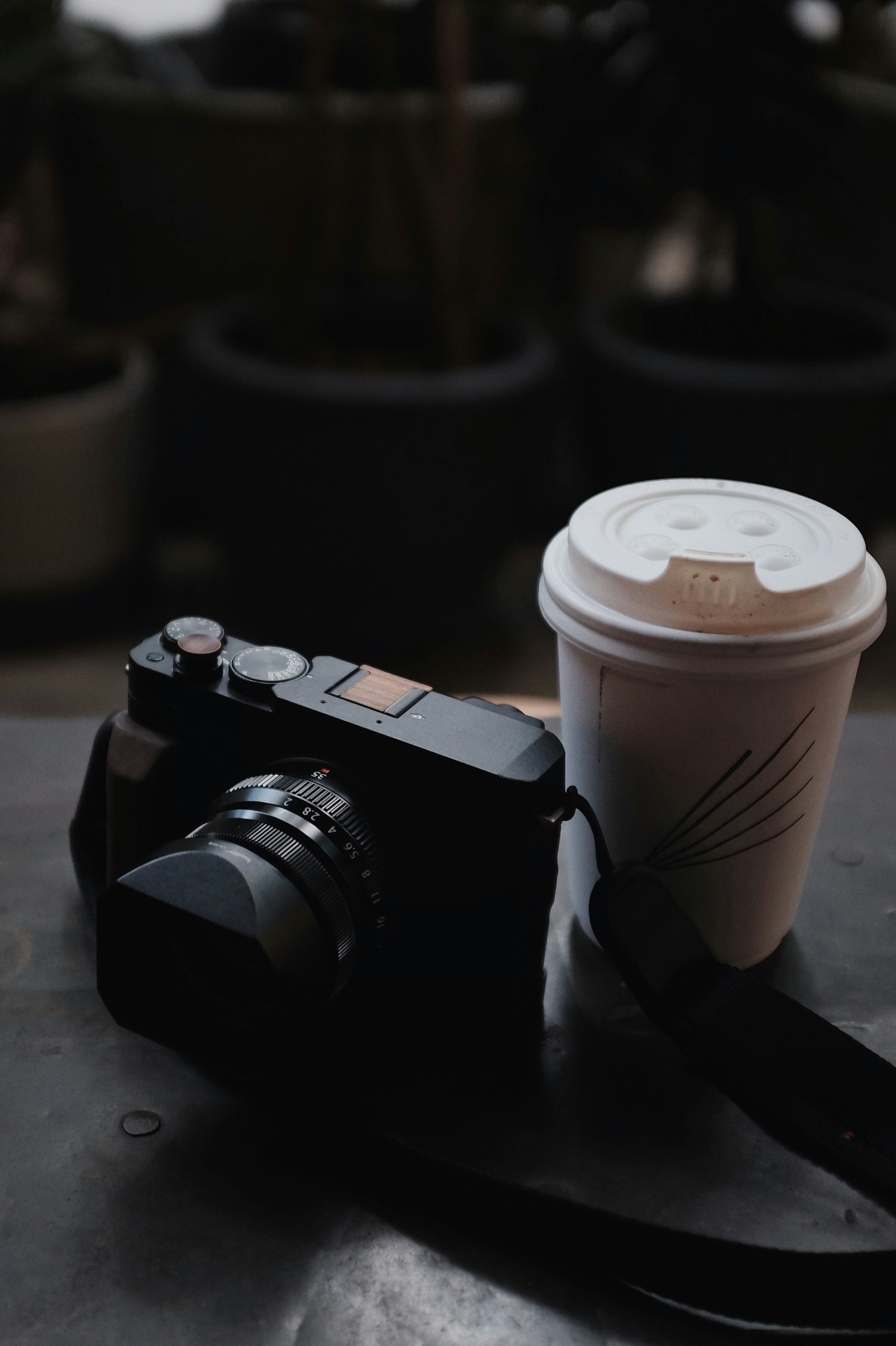 A camera and a cup of coffee on a table photo – Free Grey Image on Unsplash