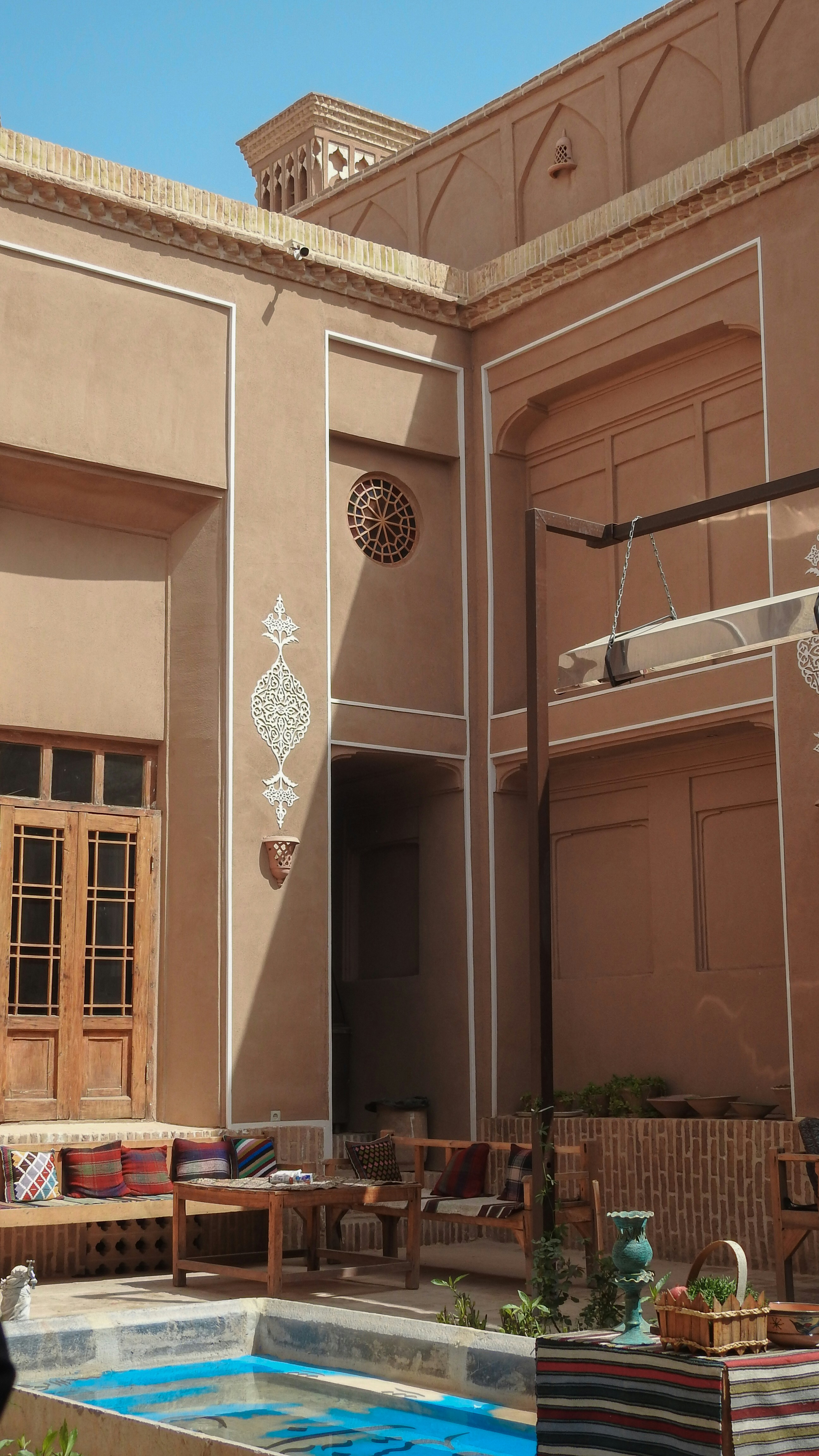 Cotten-walled Courtyard with a Shaded Veranda and Woven Cushions
