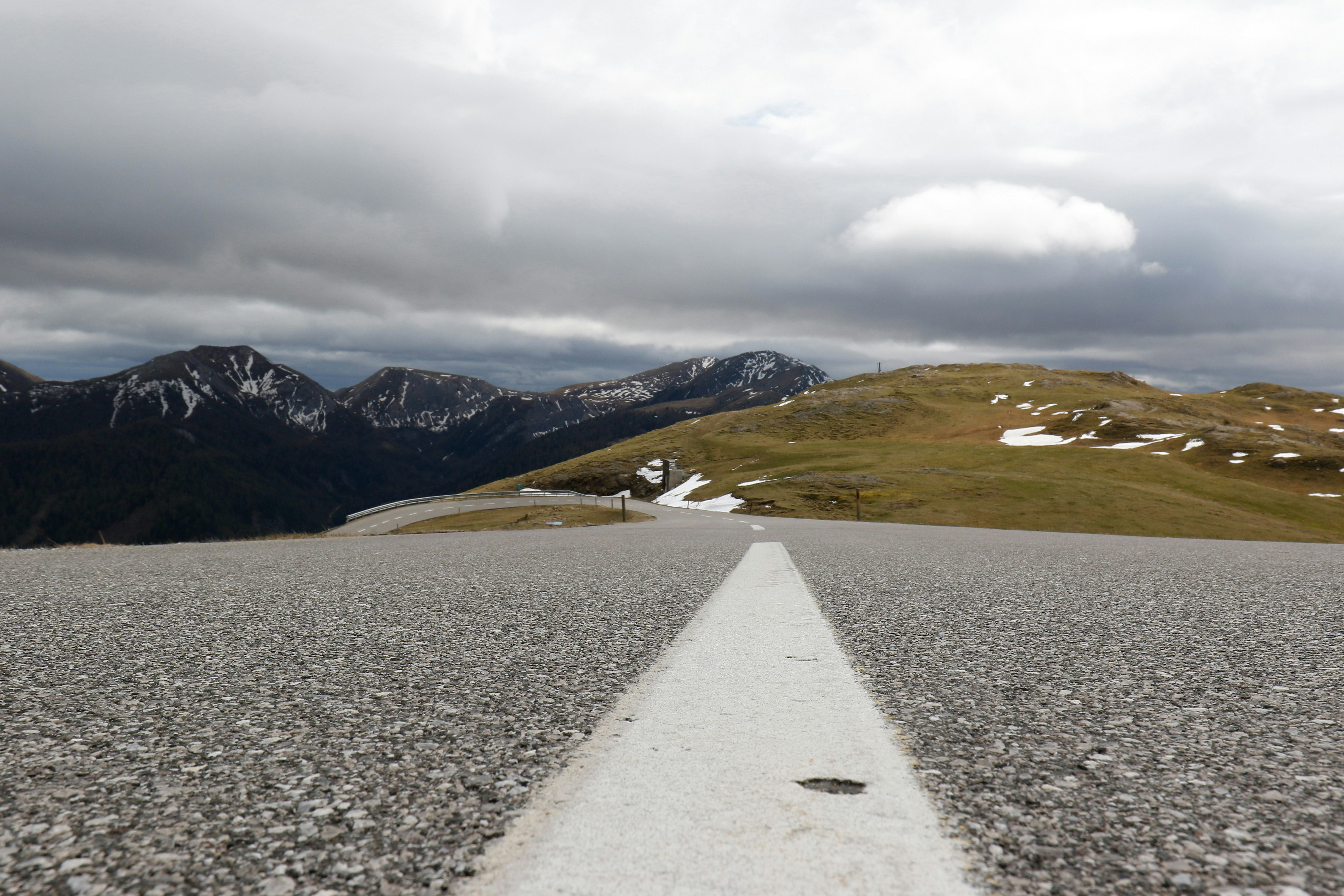 A long straight road with mountains in the background photo – Free ...