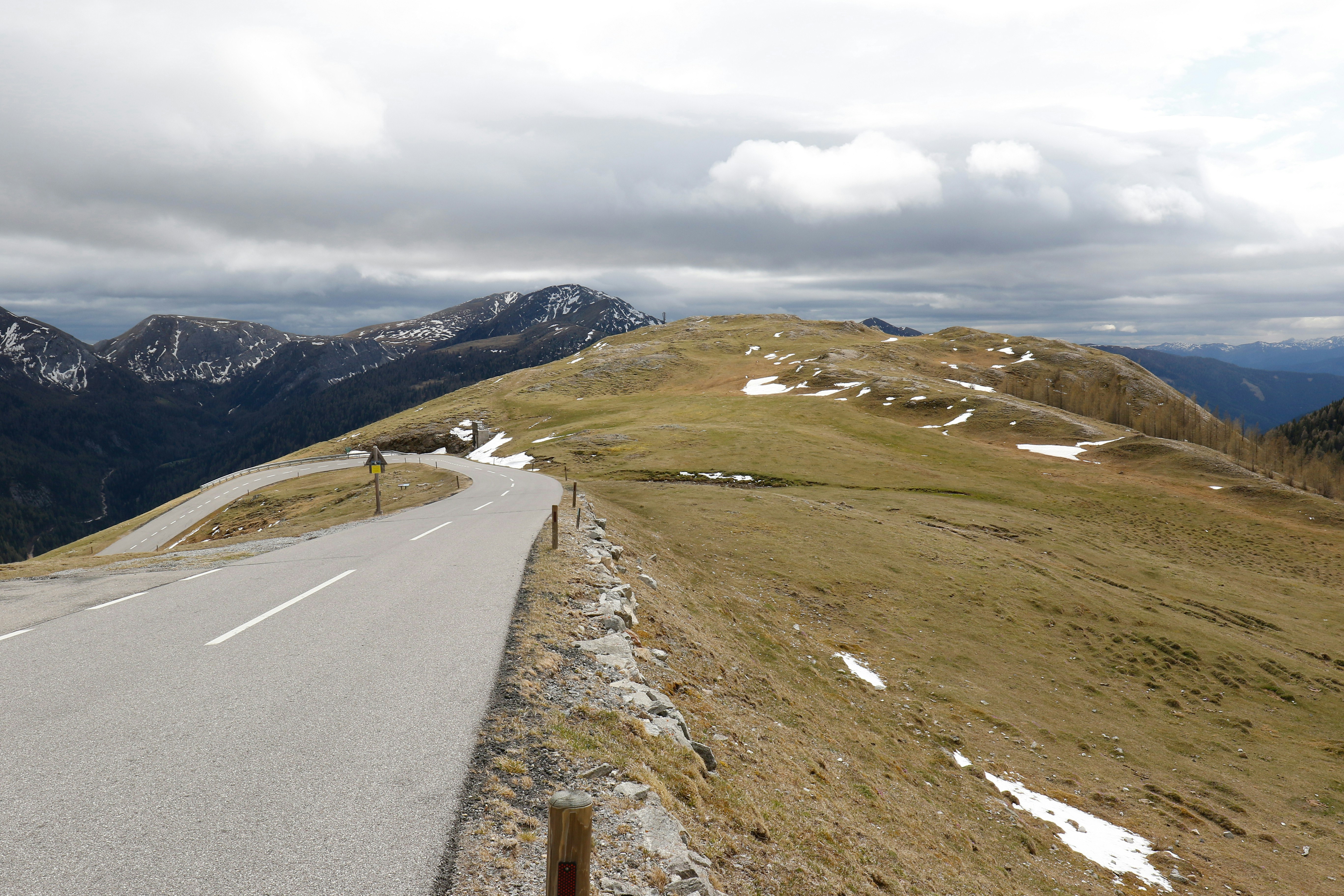 A road going down a hill with a mountain in the background photo – Free ...