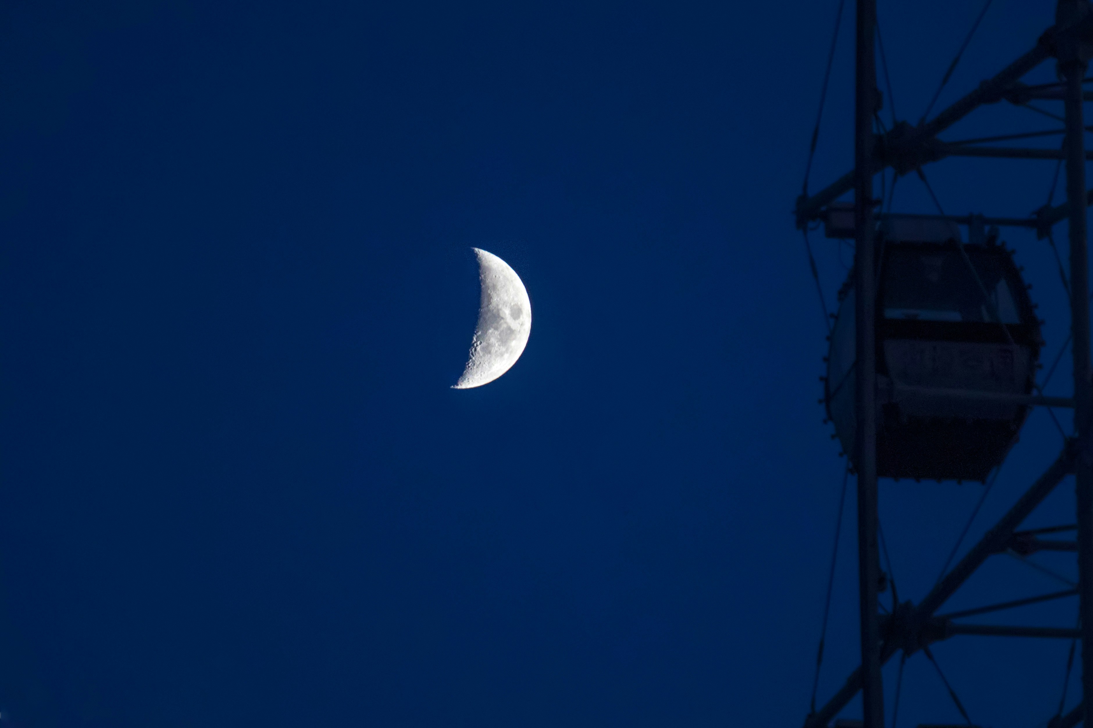 A half moon is seen in the night sky photo – Free Moon and sky wheel ...