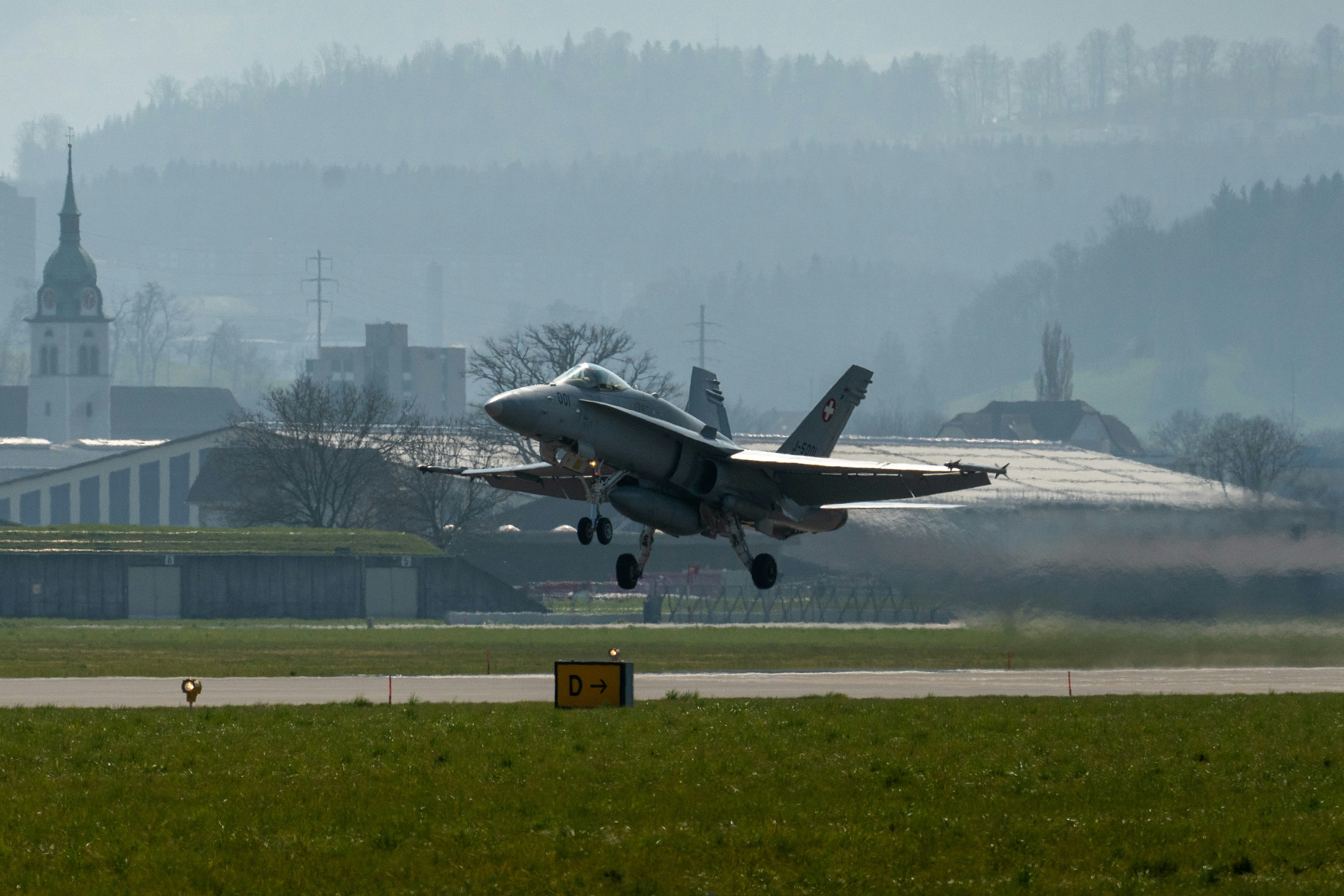A fighter jet taking off from an airport runway photo – Free ...