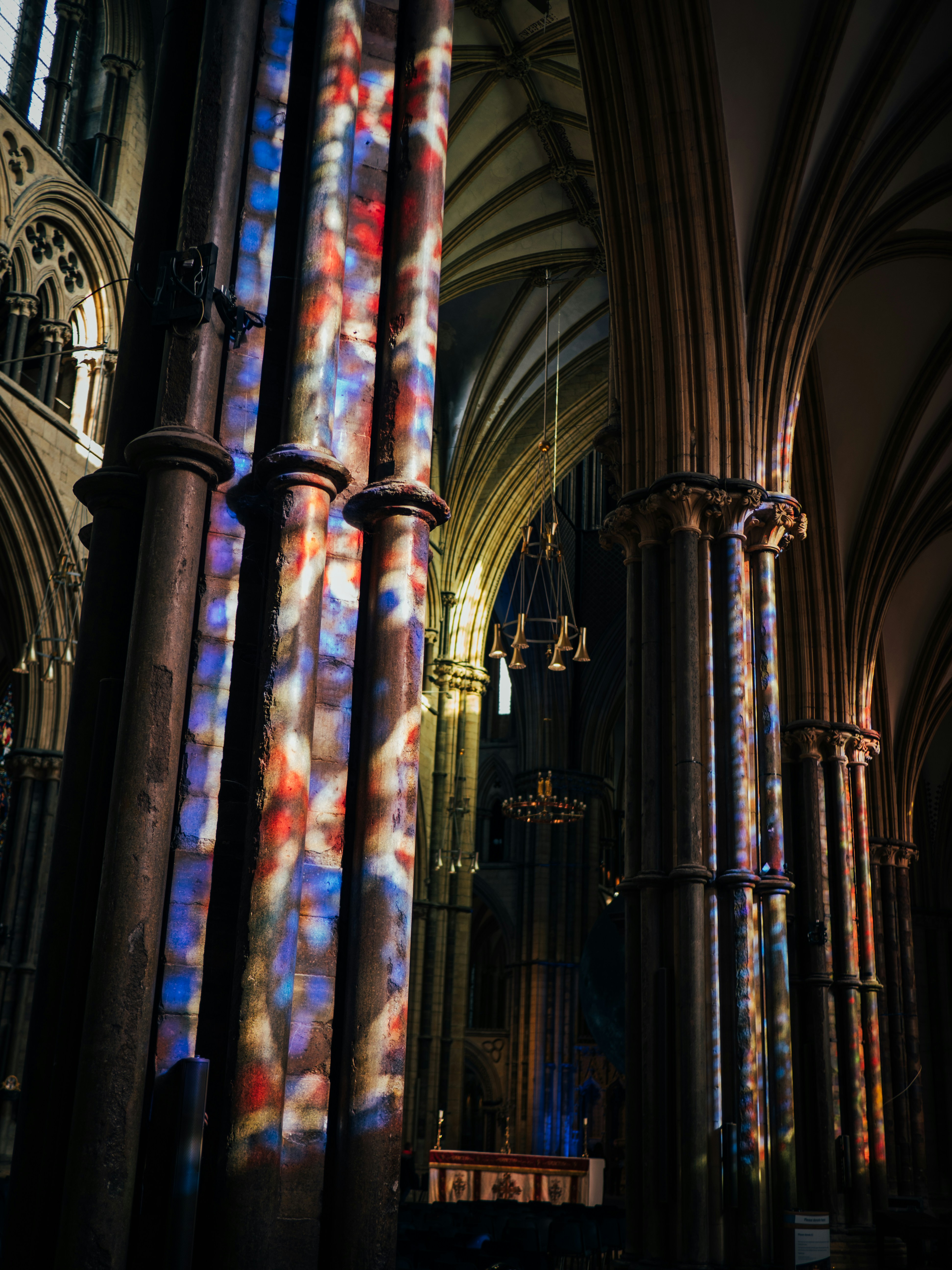 Stained glass creating colourful light at Lincoln Cathedral.