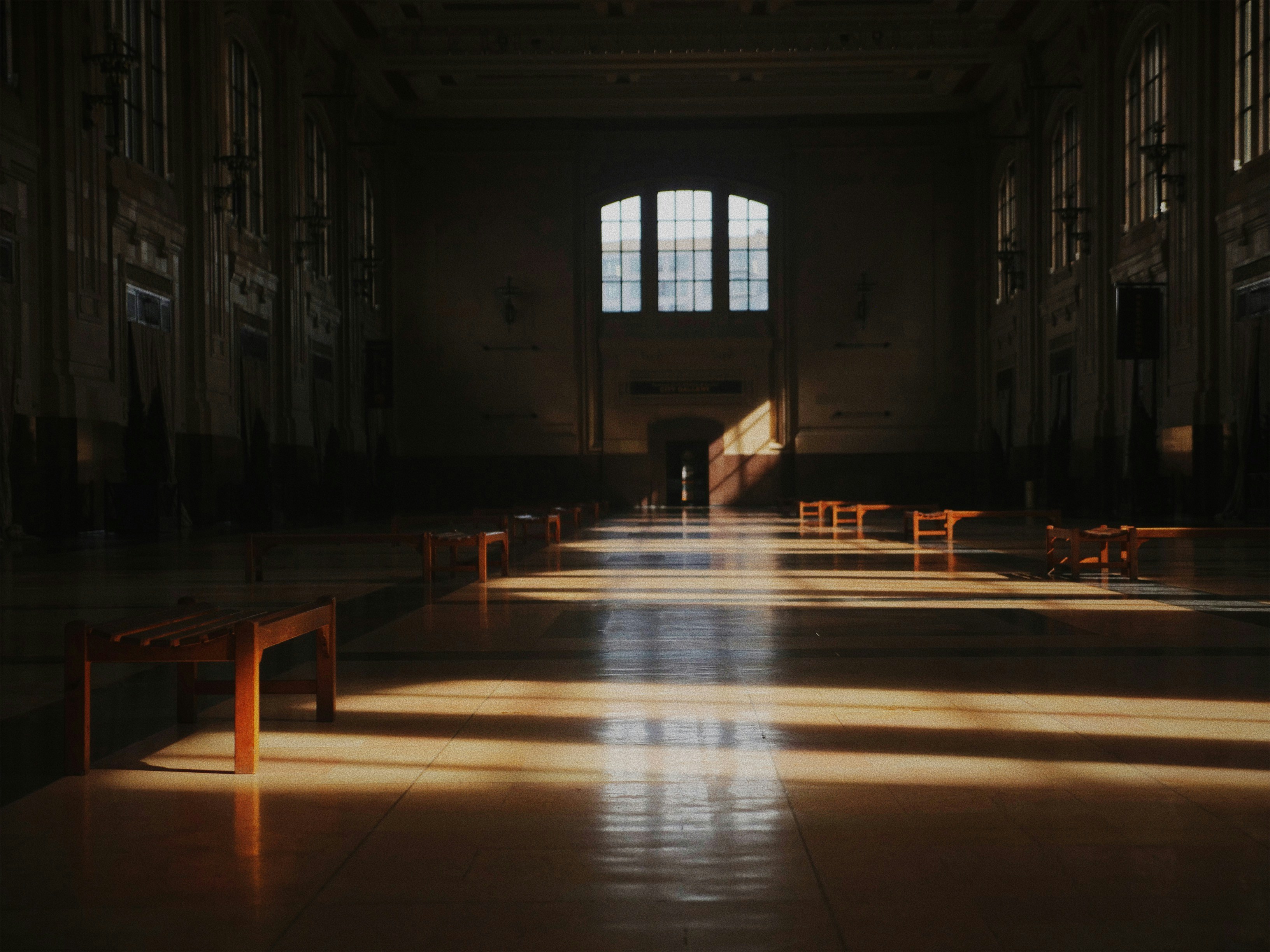 A large room with benches and windows in it photo – Free Floor Image on ...