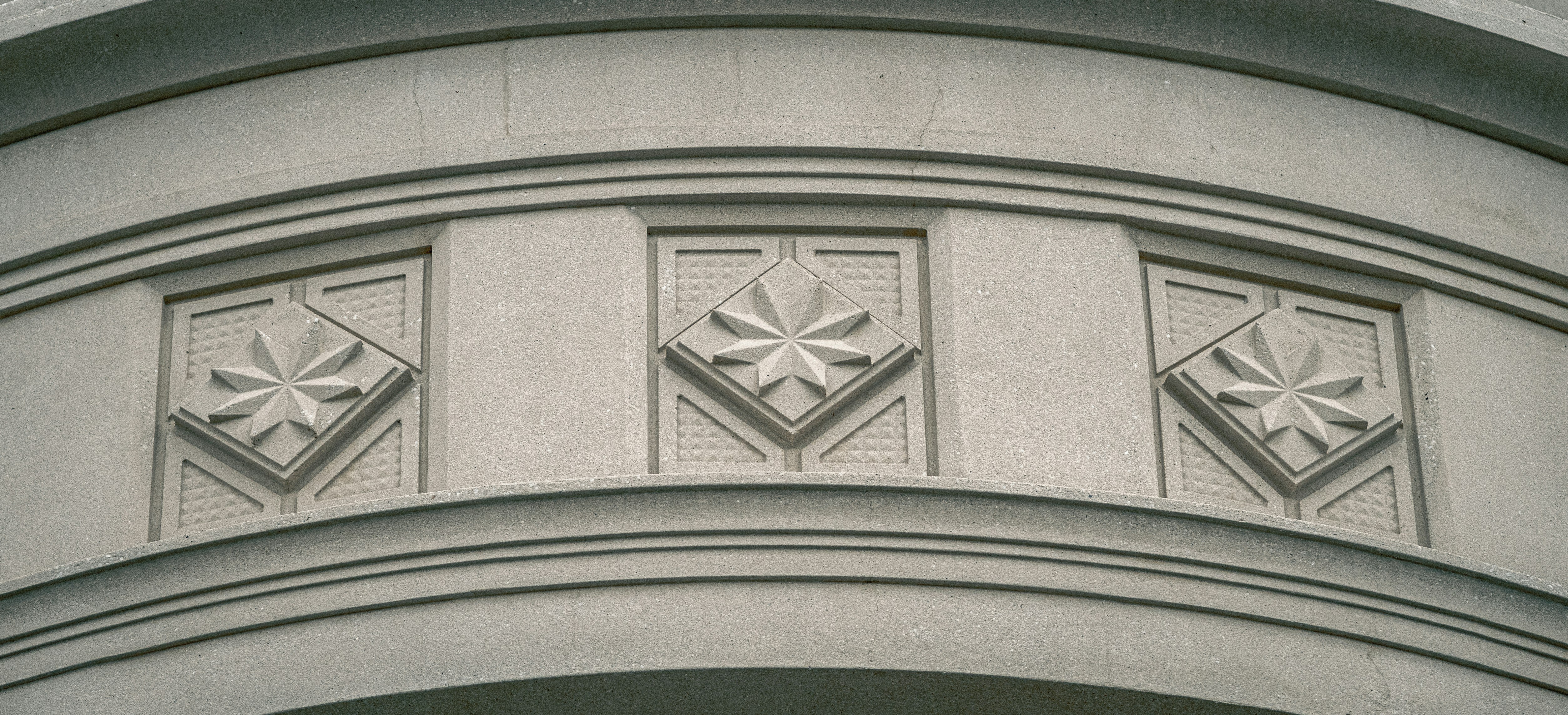 Stone Frieze of Eight-Pointed Stars Along a Curved Arch