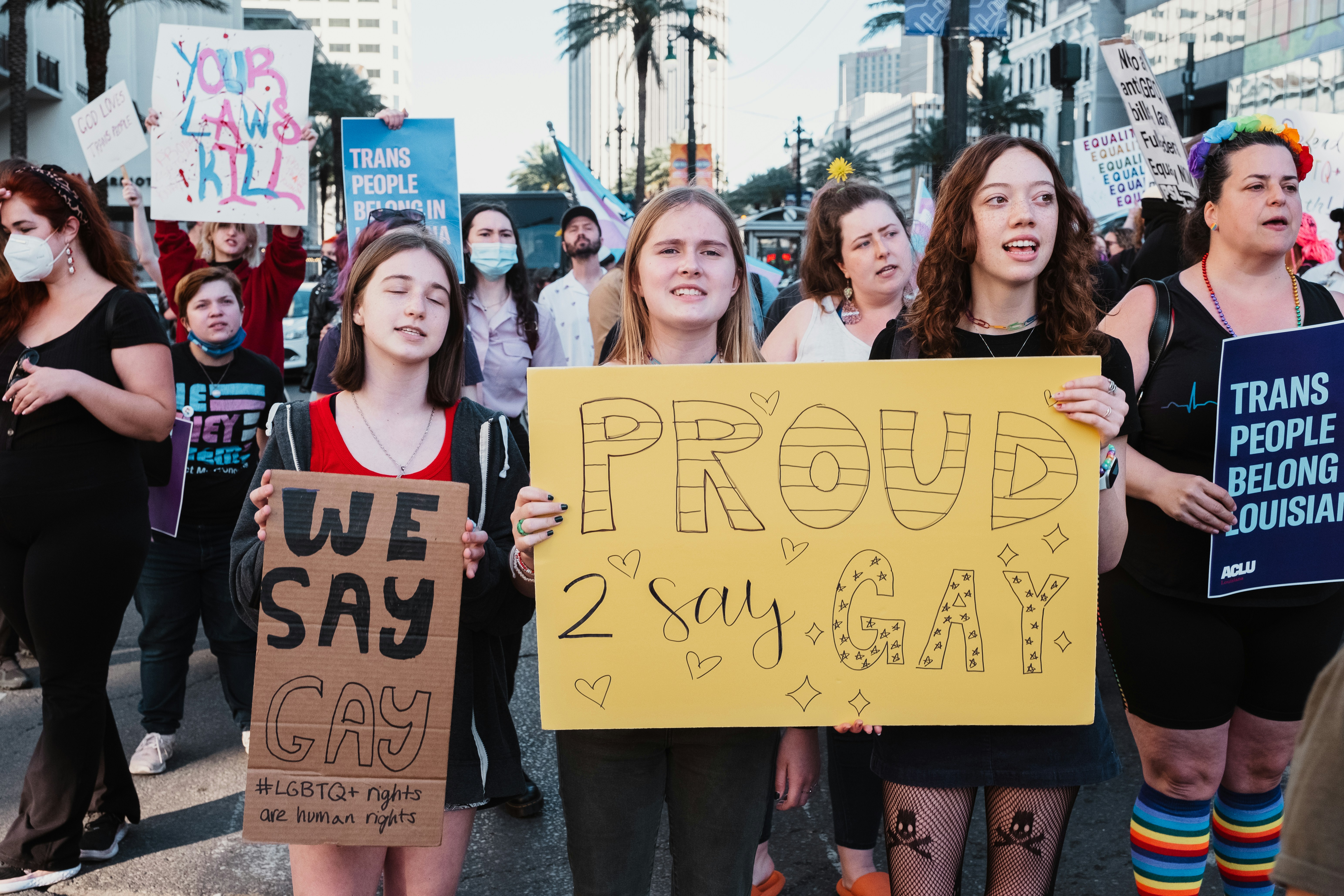 A group of people holding signs and protesting photo – Free Pride Image ...
